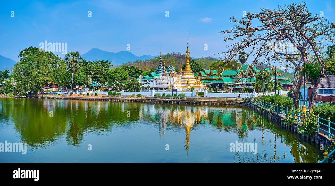 The picturesque panorama of Nong Kham lake, lined with lush greenery of ...