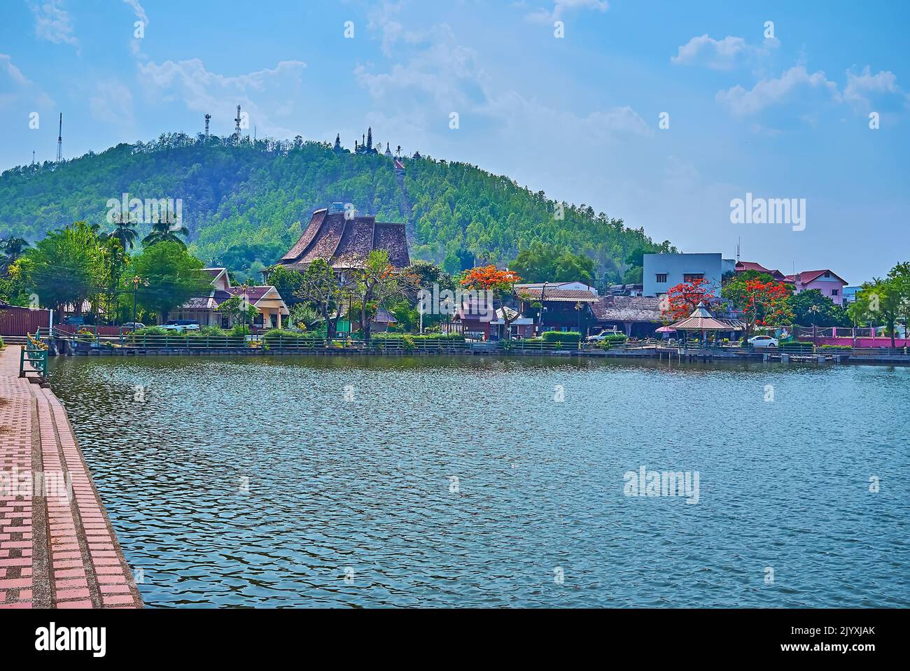 The scenic green Doi Kong Mu Hill is seen behind the roofs of Mae Hong ...
