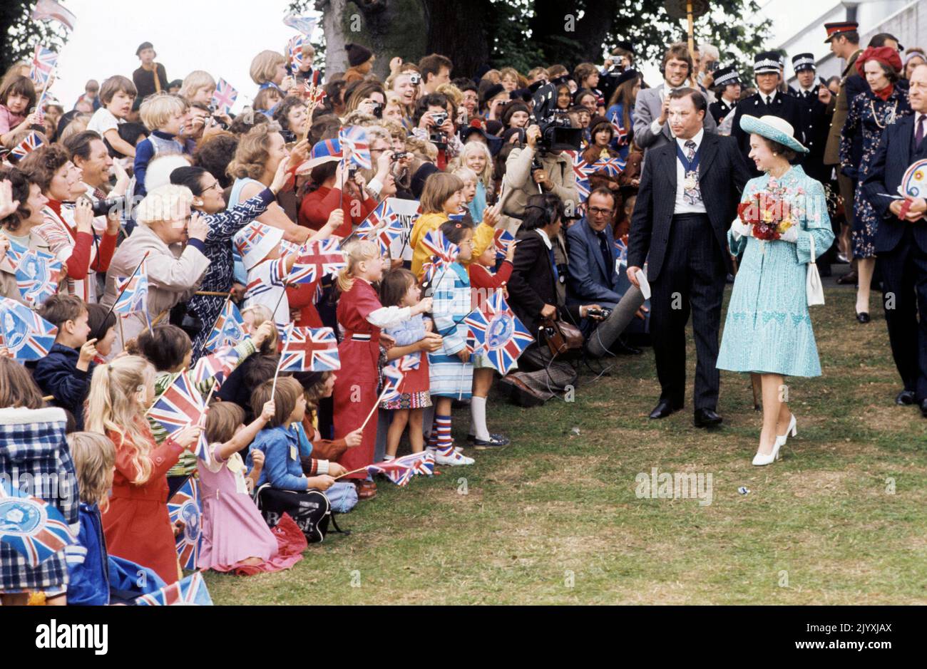File photo dated 28/7/1977 of children welcoming Queen Elizabeth II as ...
