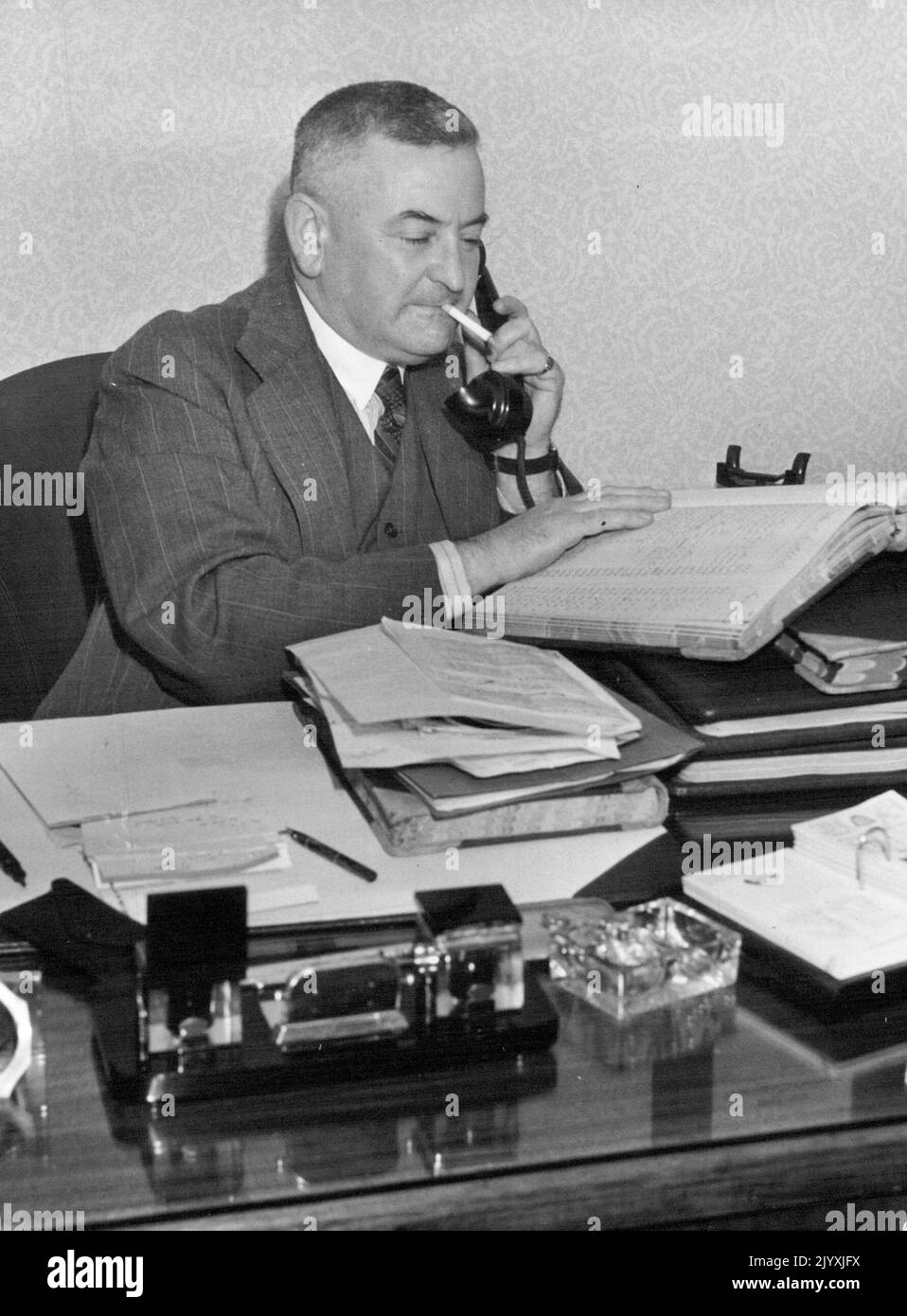 Mr E.S. Spooner does three things at once listens for a "Phone" call ...