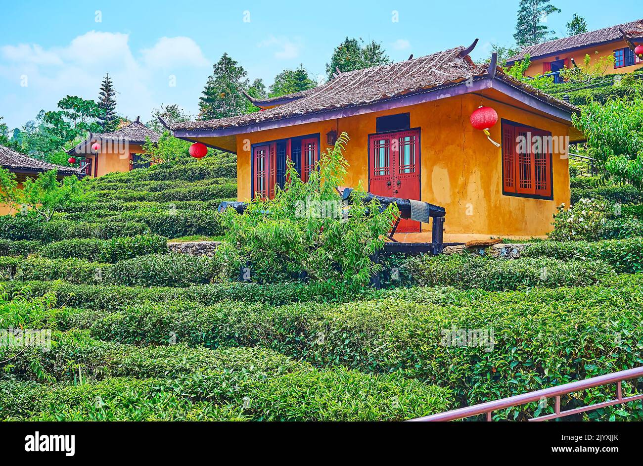 The small Chinese houses with traditional sweeping roofs, red lanterns ...