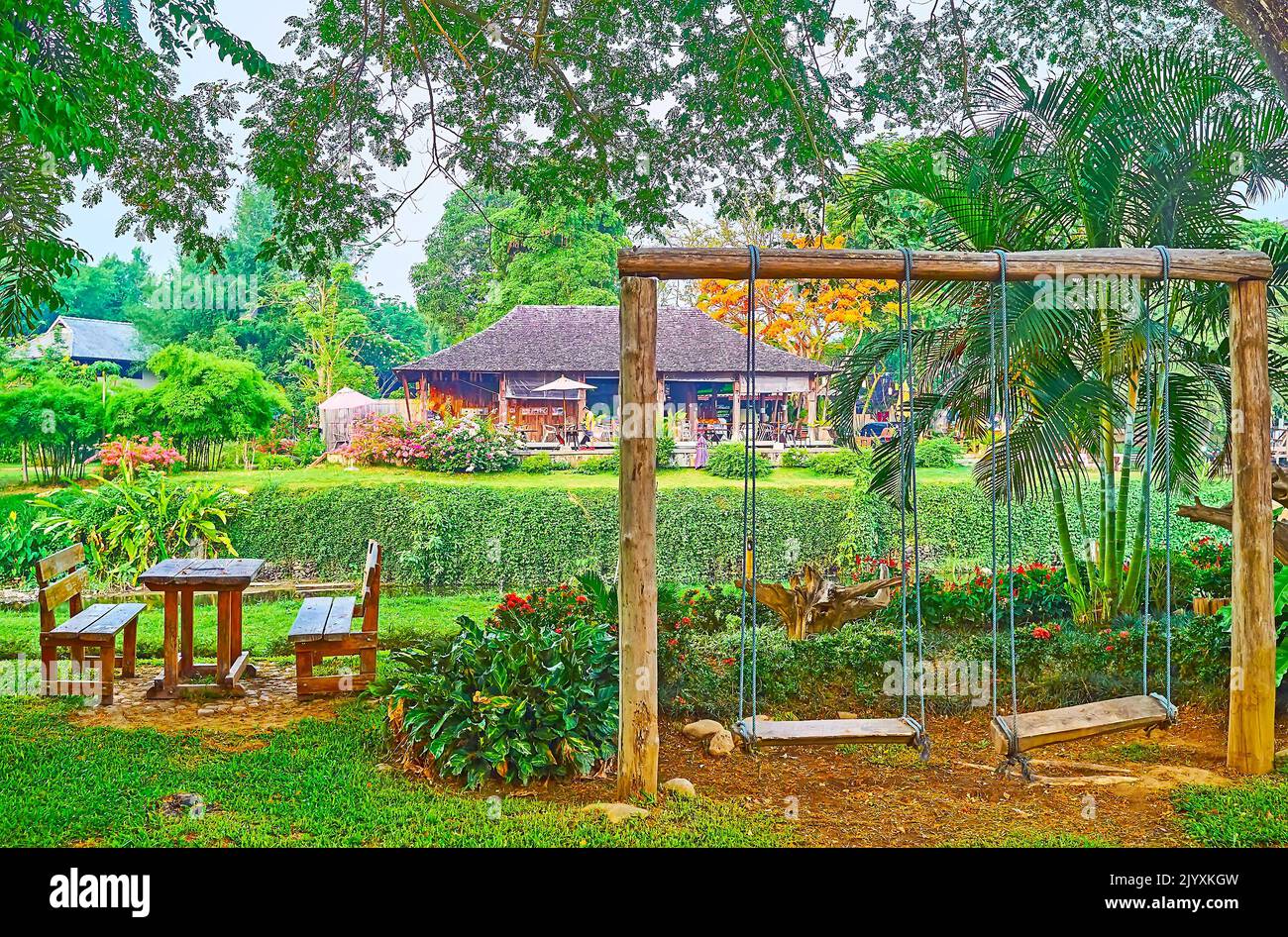 The recreation area on the bank of Pai River with small wooden tables ...