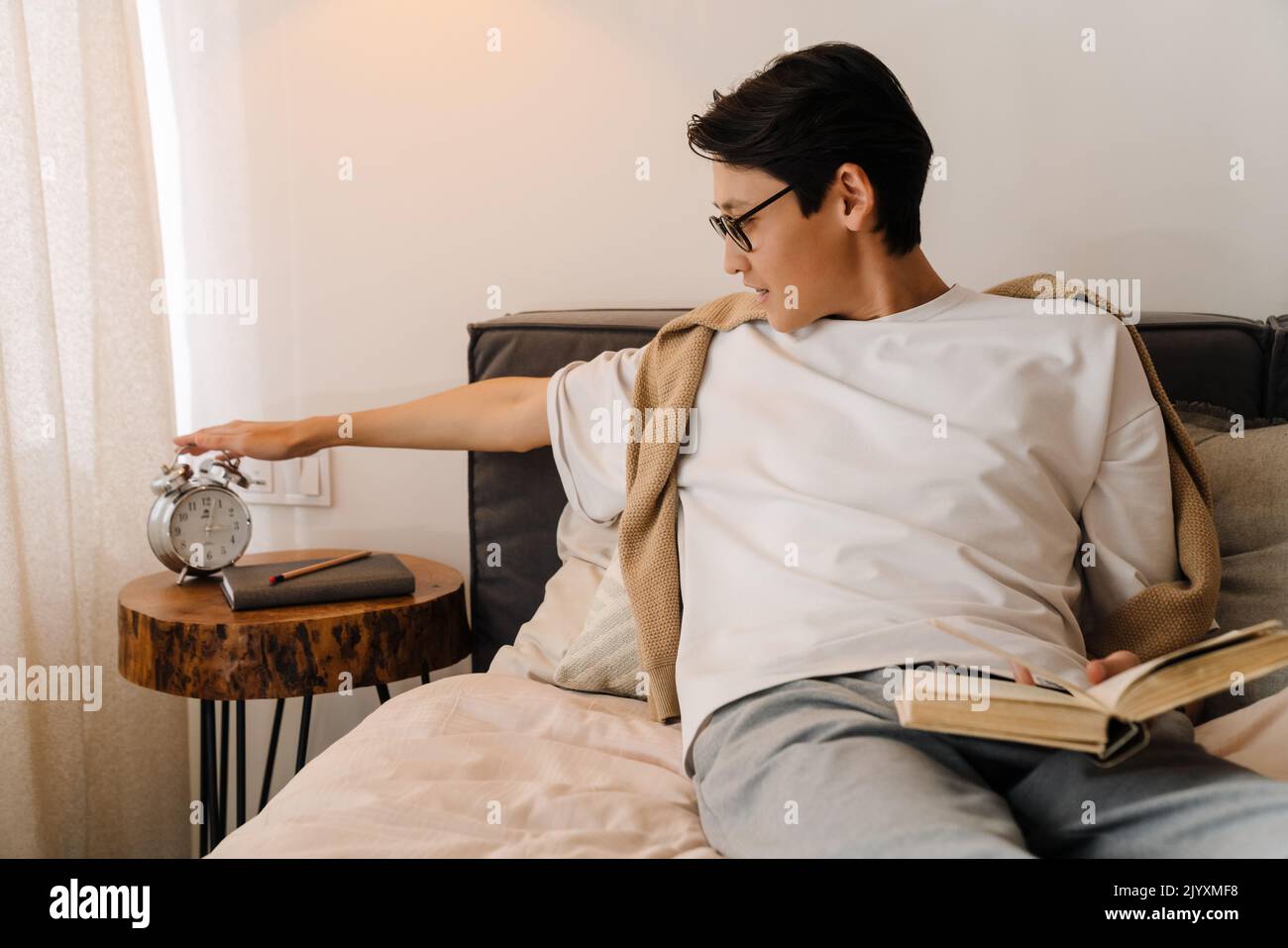 Asian teen boy reading book hi-res stock photography and images - Alamy