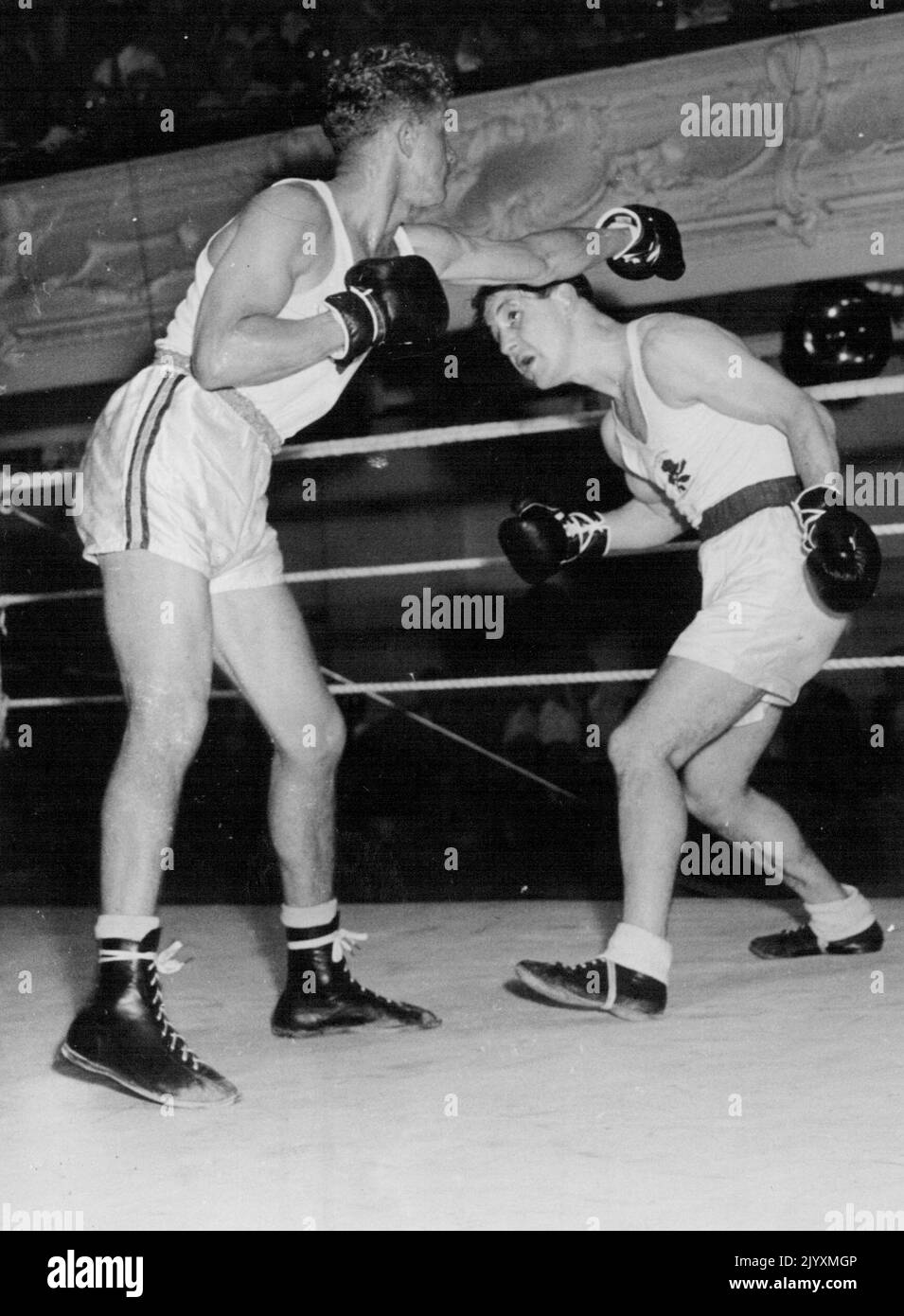 R. Latham (England) slips a left past W. Barber (Australia) in their ...
