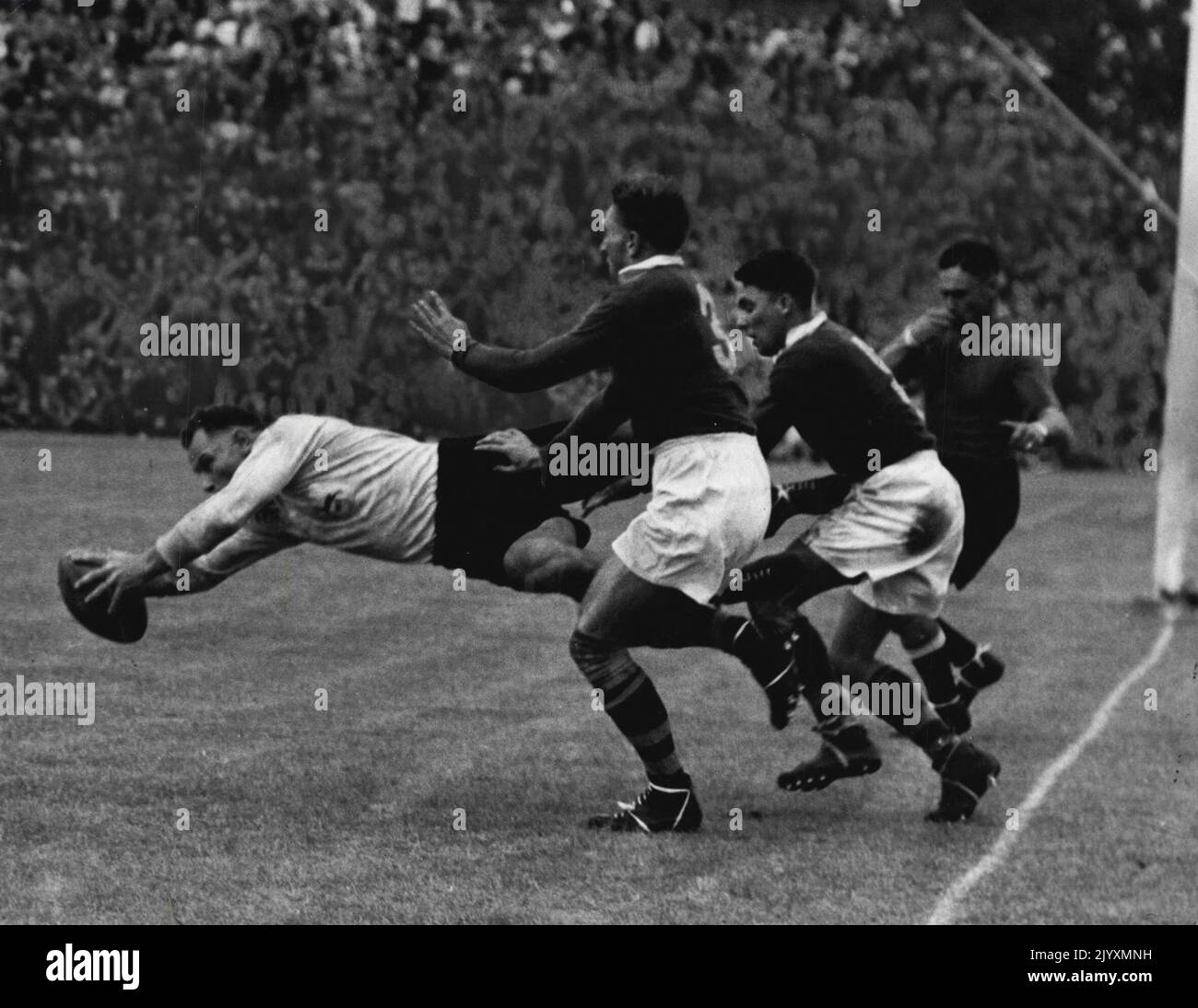 Chris Koch, dashing Springbok front-row forward, dives over for a try ...