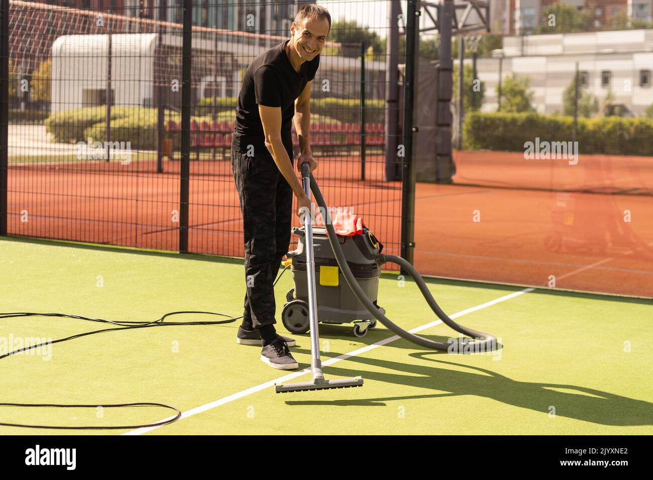 man with professional vacuum cleaner for the tennis court Stock Photo ...