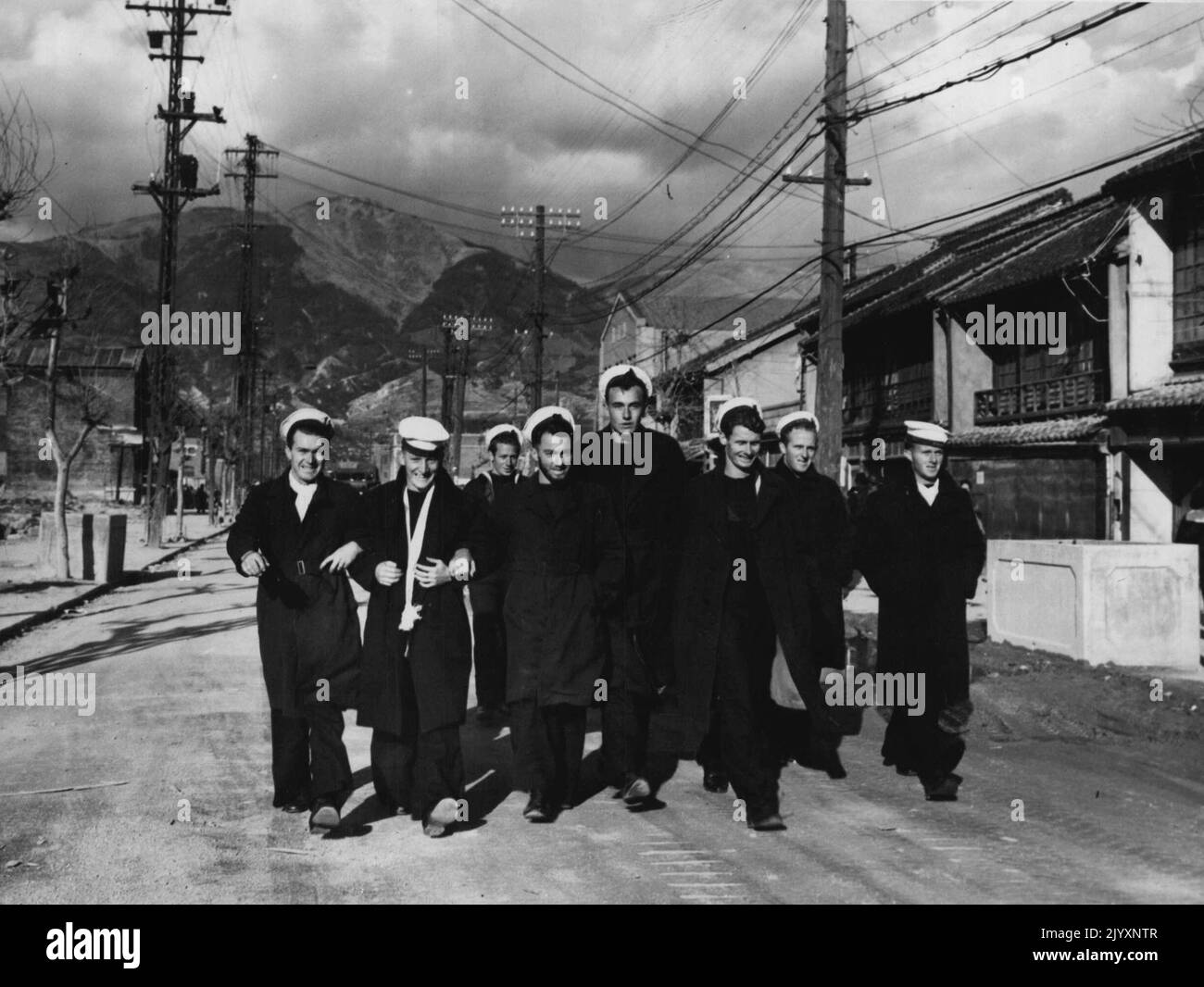sailors of HMAS ships walk through one of the ***** bomb damage is ...