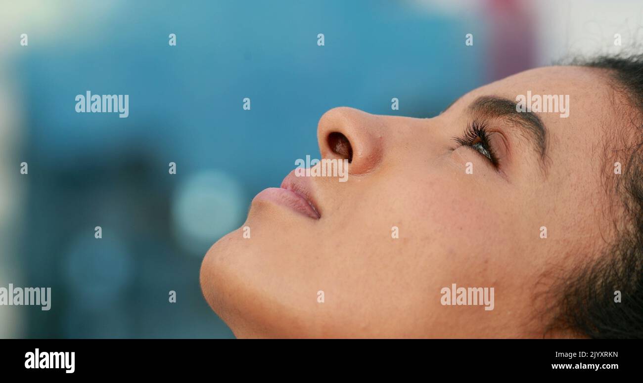 Young black african woman looking upwards to the sky opening eyes Stock ...