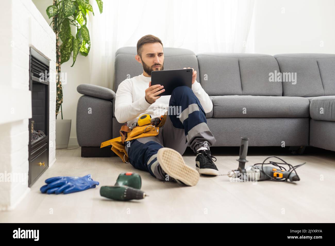 building master examines a new fireplace Stock Photo - Alamy