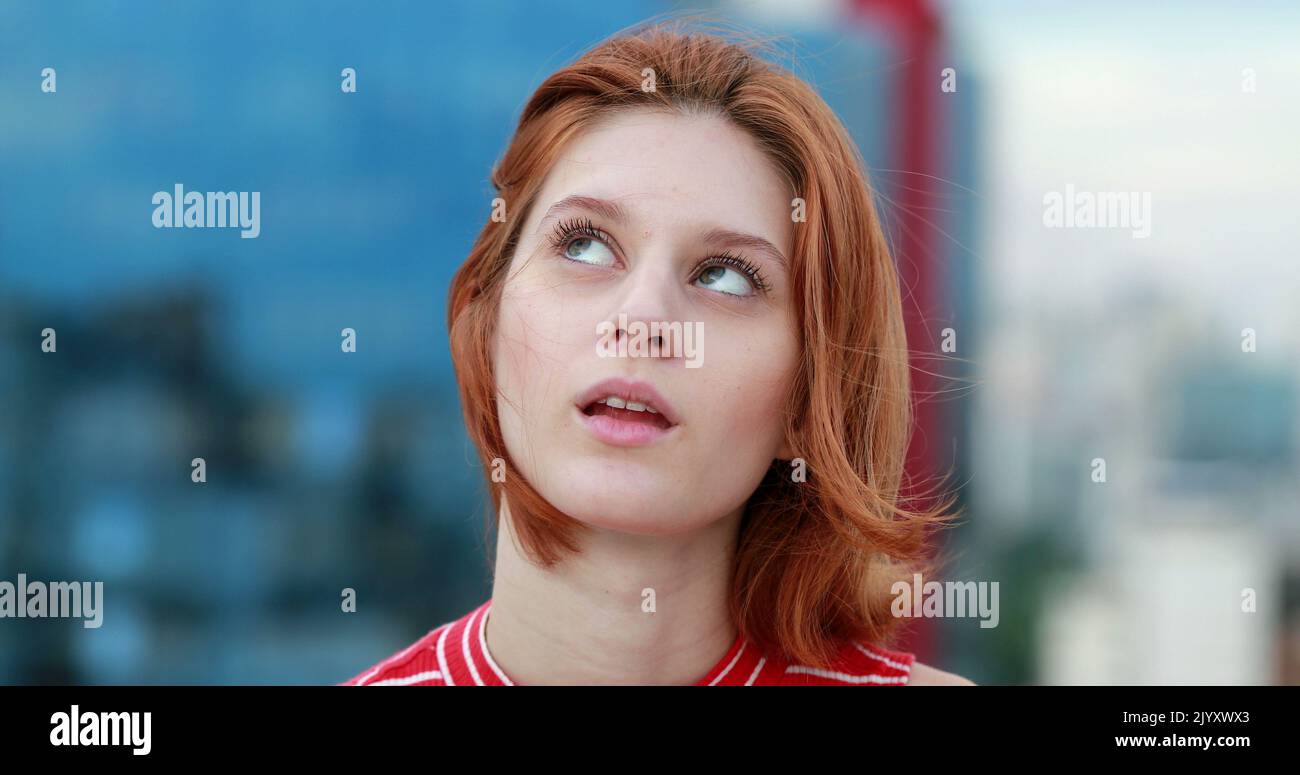 Woman with a bored emotion on face. Redhead girl rolling eyes Stock ...