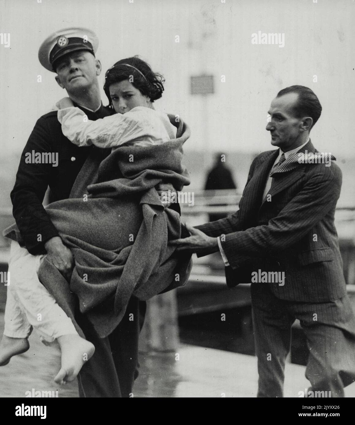 A ***** girl is carried away at Fort Macquarie by an ambulance officer ...