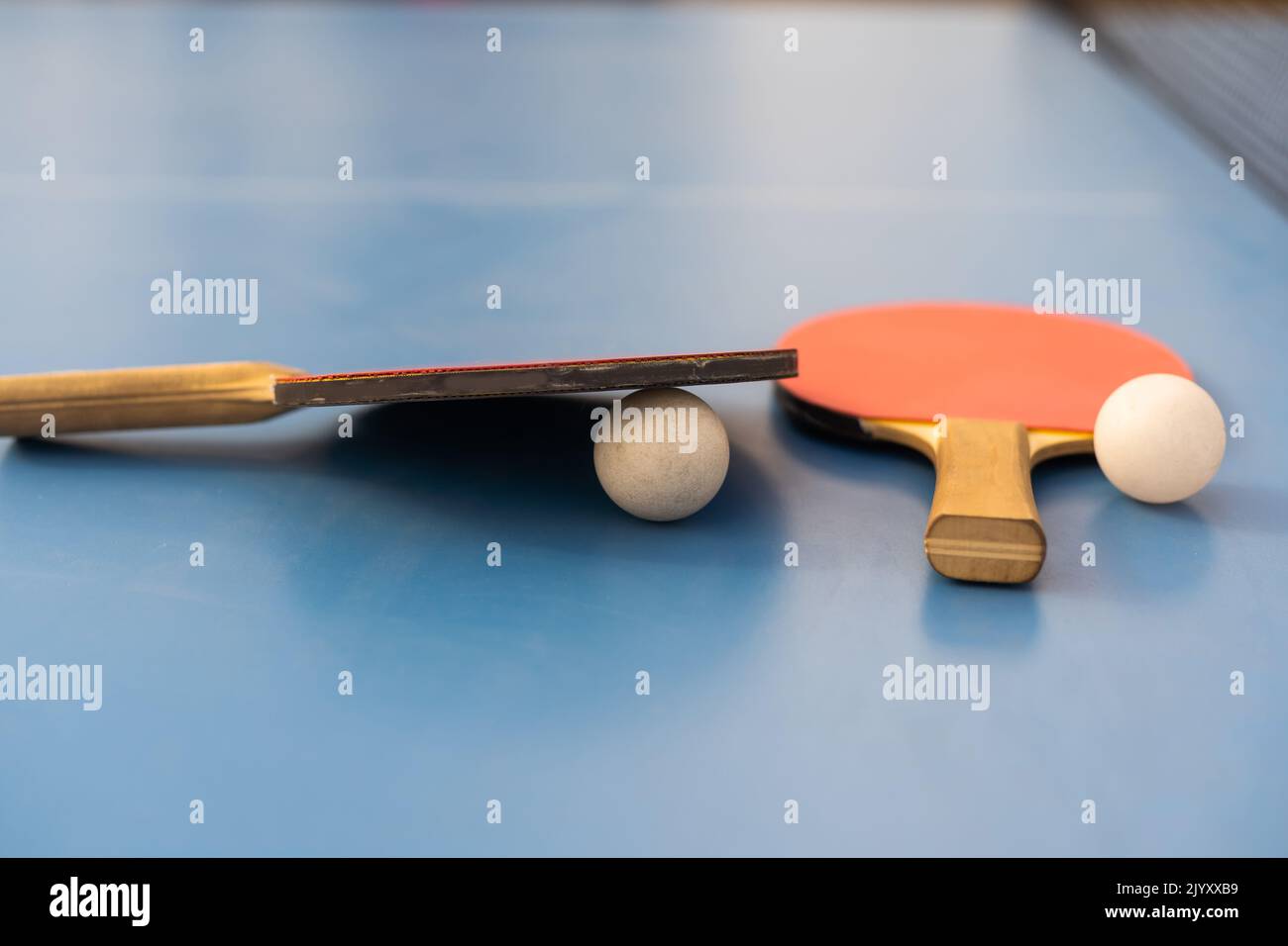Ping pong table, rackets and balls in a sport hall Stock Photo - Alamy
