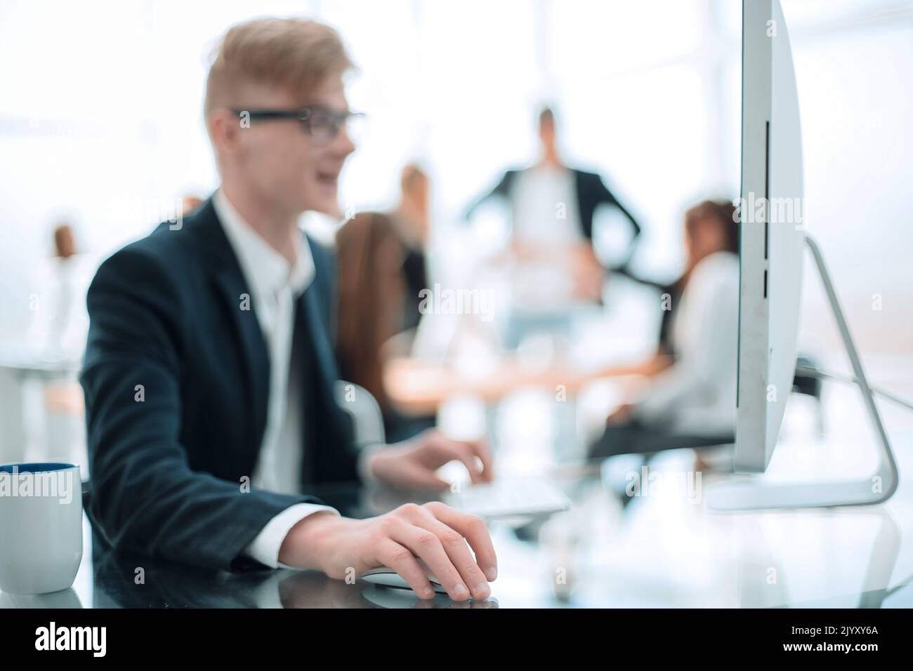 close up. a young businessman working on a computer in a modern office ...