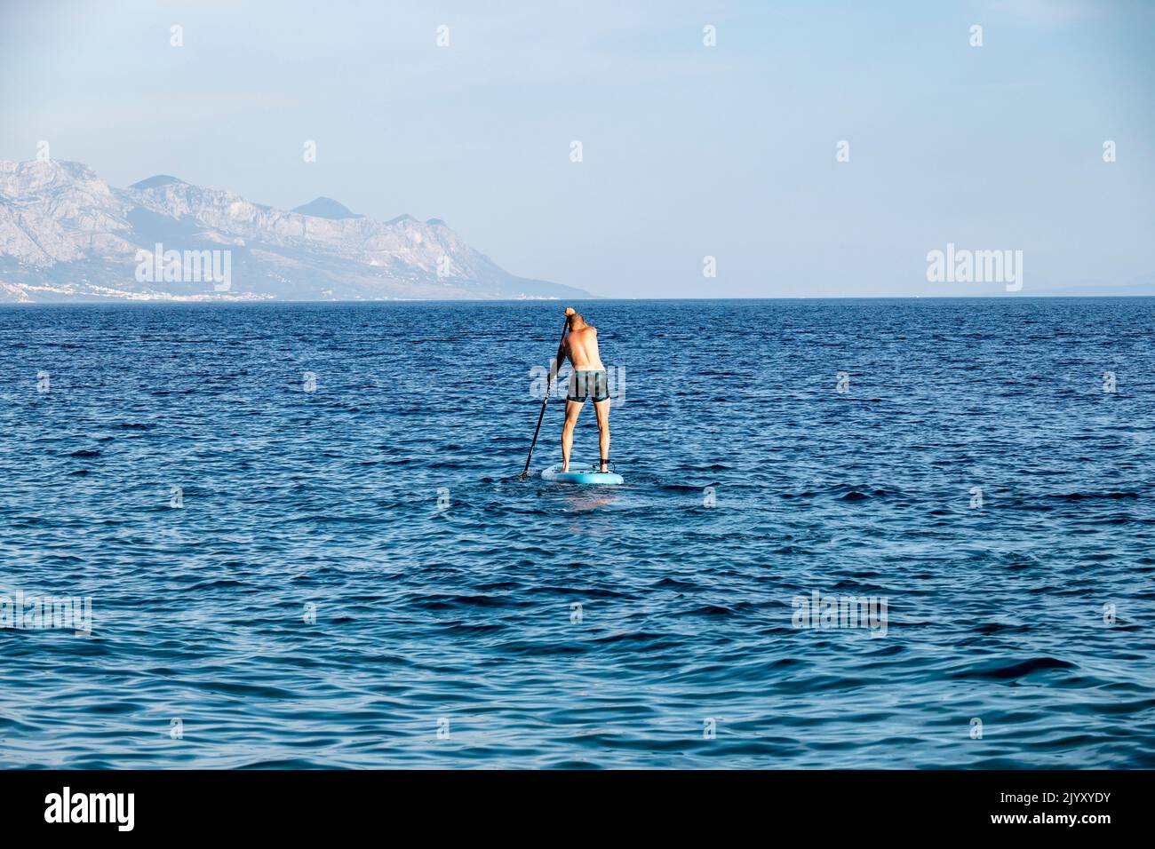 Mimice, Croatia-August 16th, 2022: Man standing and rowing on his ...