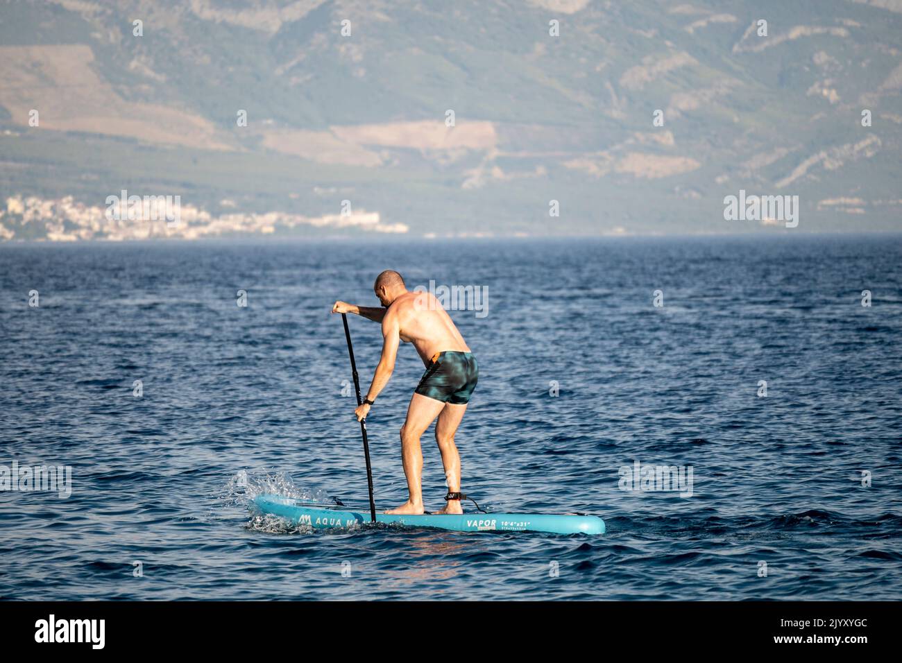 Mimice, Croatia-August 16th, 2022: Man standing and rowing on his ...