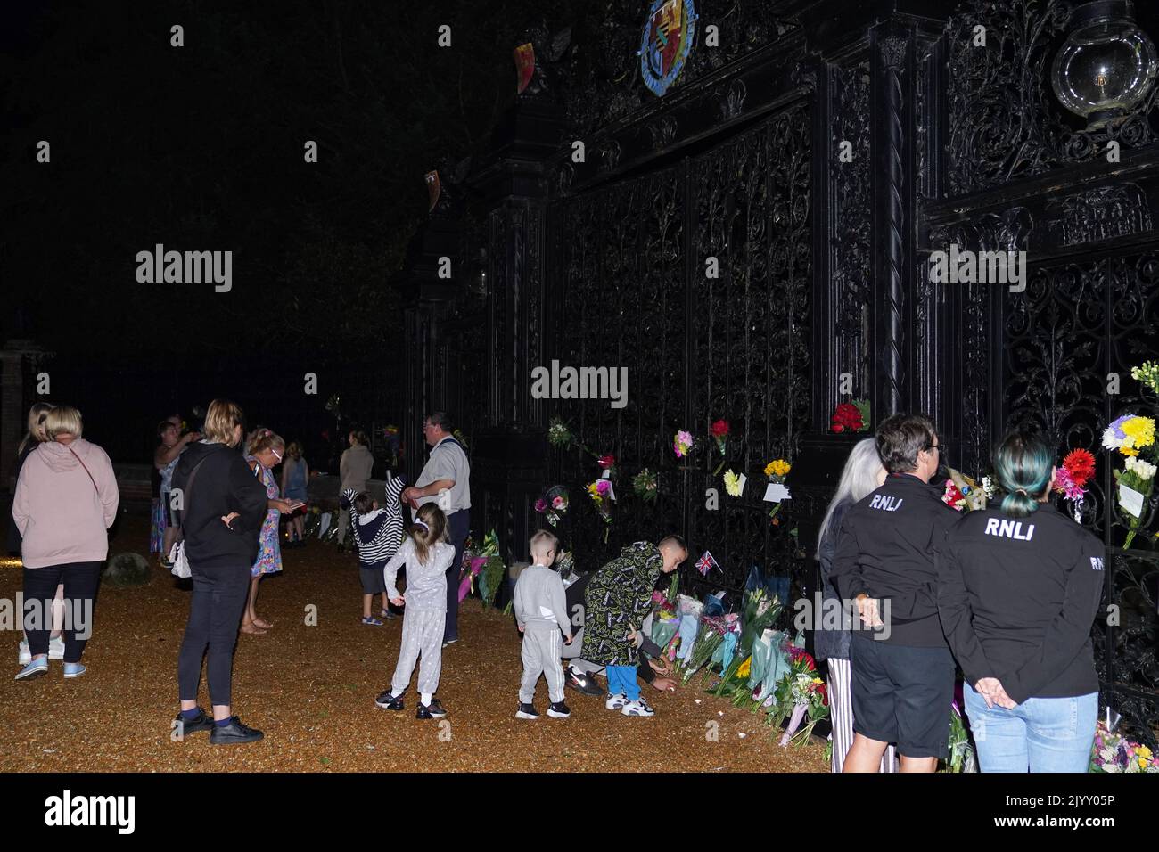 People lay flowers and pay their respects at the gate of Sandringham ...