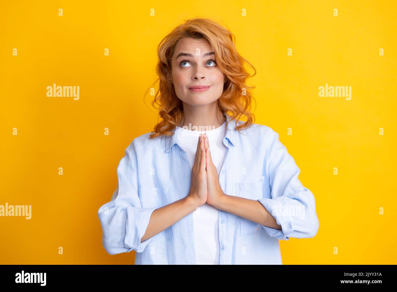 Portrait of happy woman smiling and saying prayer. Pretty girl enjoys ...
