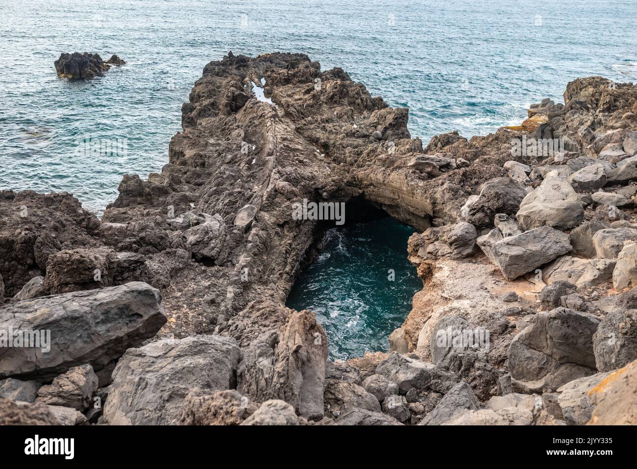 Basalt rocks in the ocean. Volcanic texture of rocky coastline Stock ...