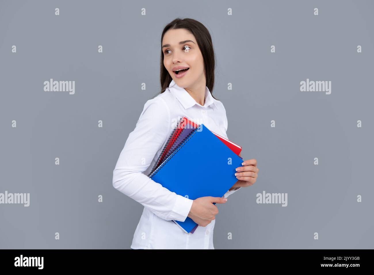 Teenager student girl isolated on grey background. Cheerful young woman ...