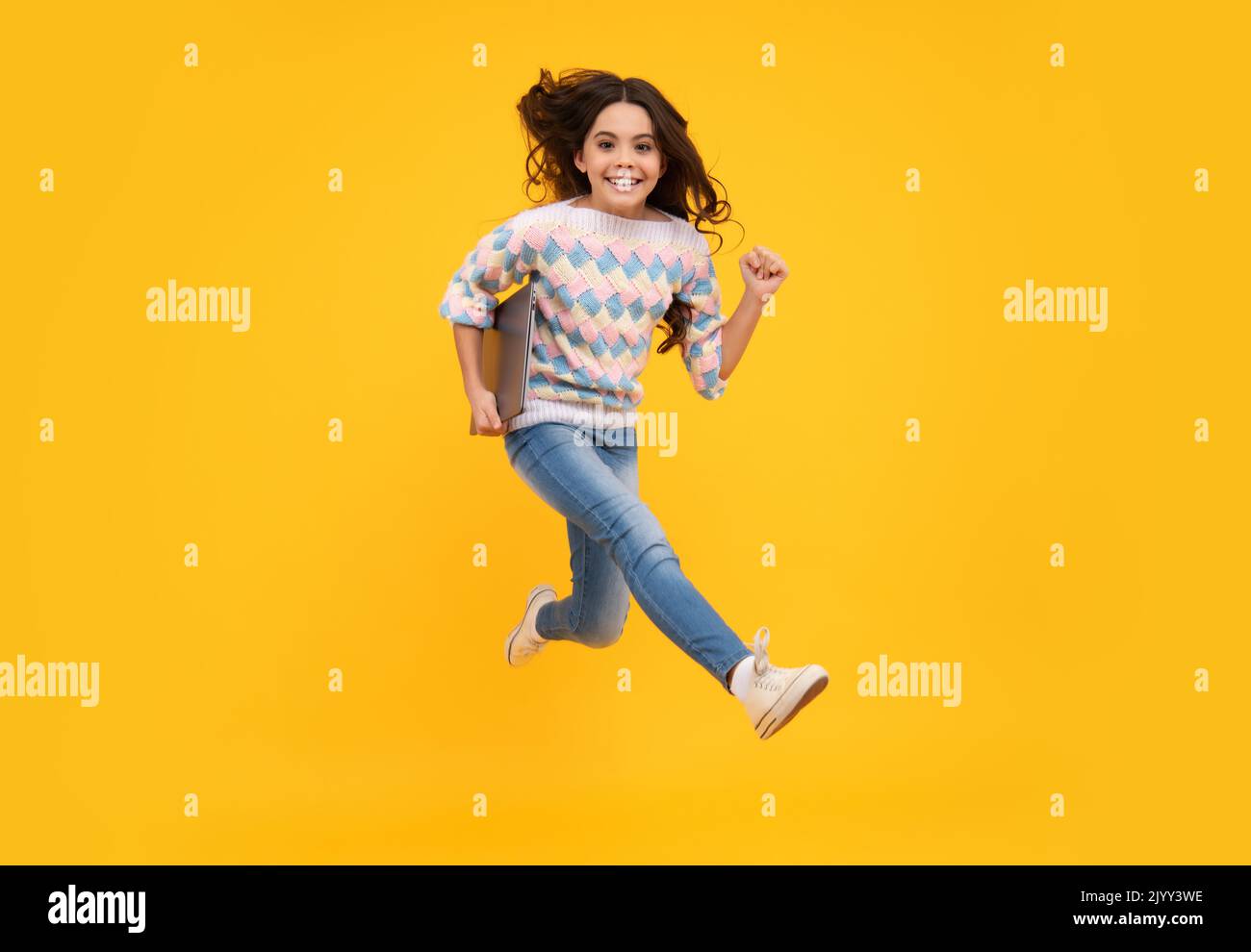 Young student school girl, studying with laptop computer. Run and jump ...