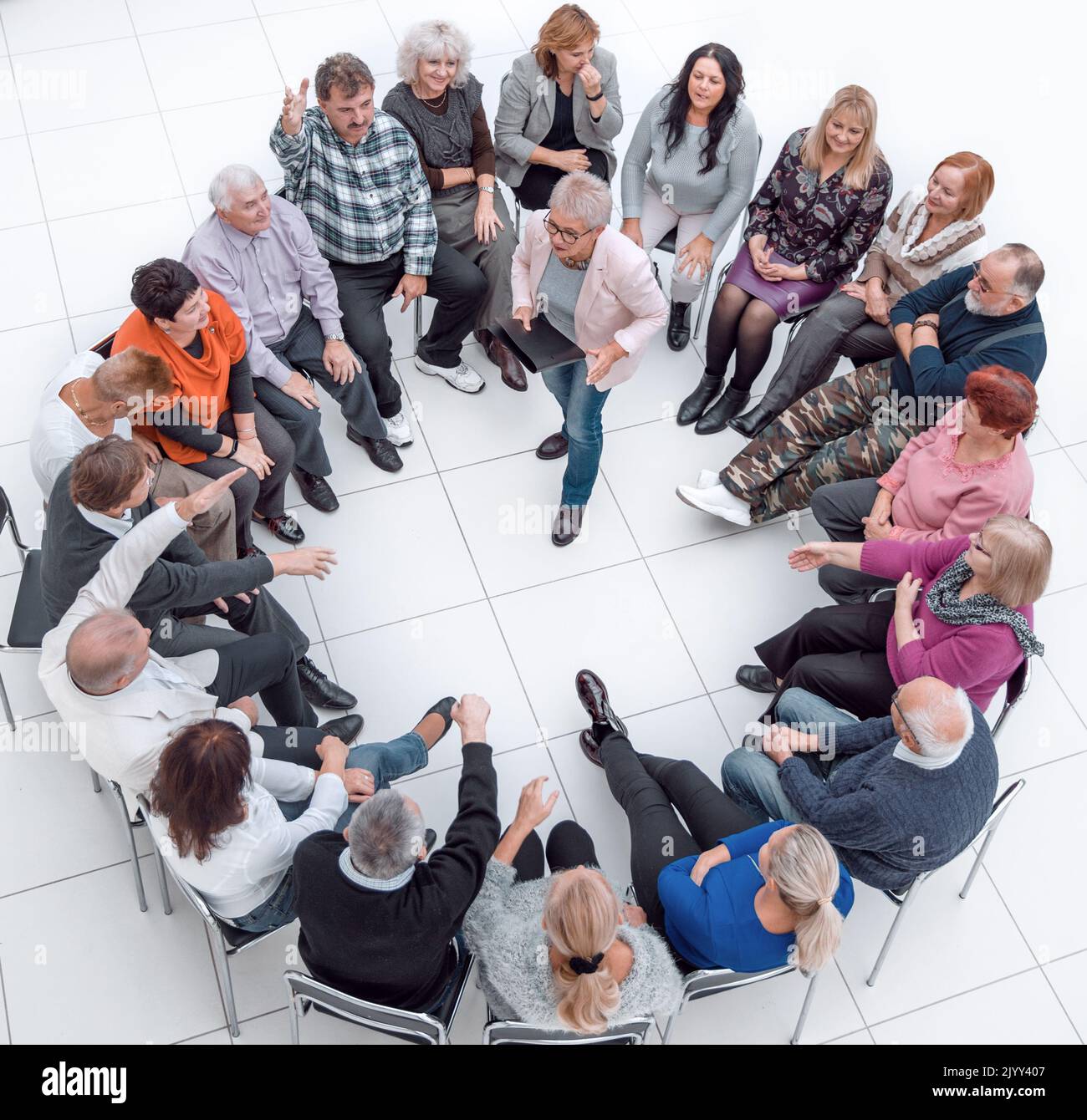confident older woman standing in a circle of like-minded people Stock ...