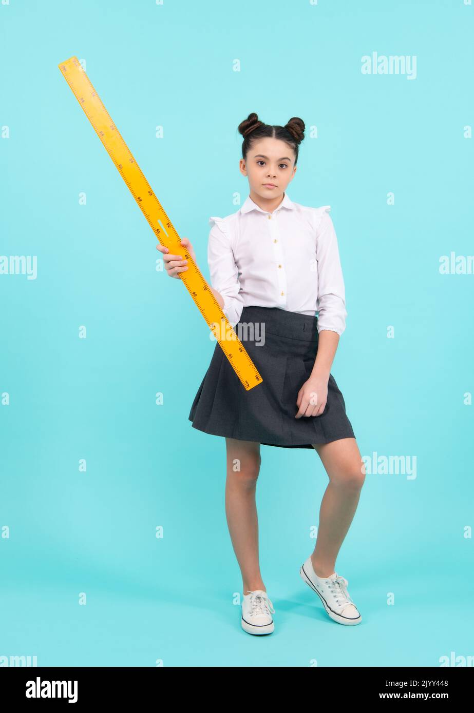 Teenager child school girl holding measure for geometry lesson ...