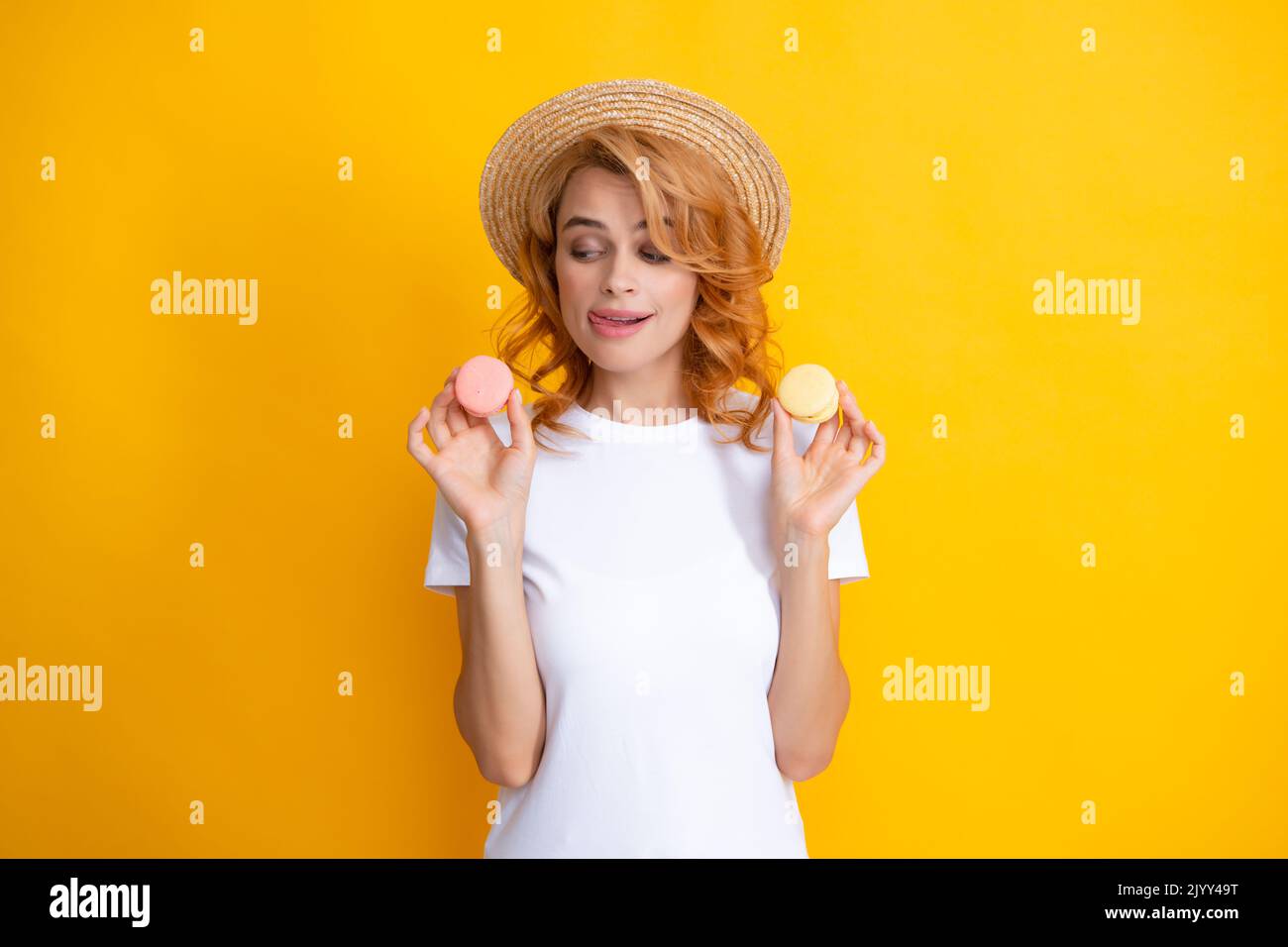 Beauty model girl taking colorful macaroons. Beautiful woman eating ...