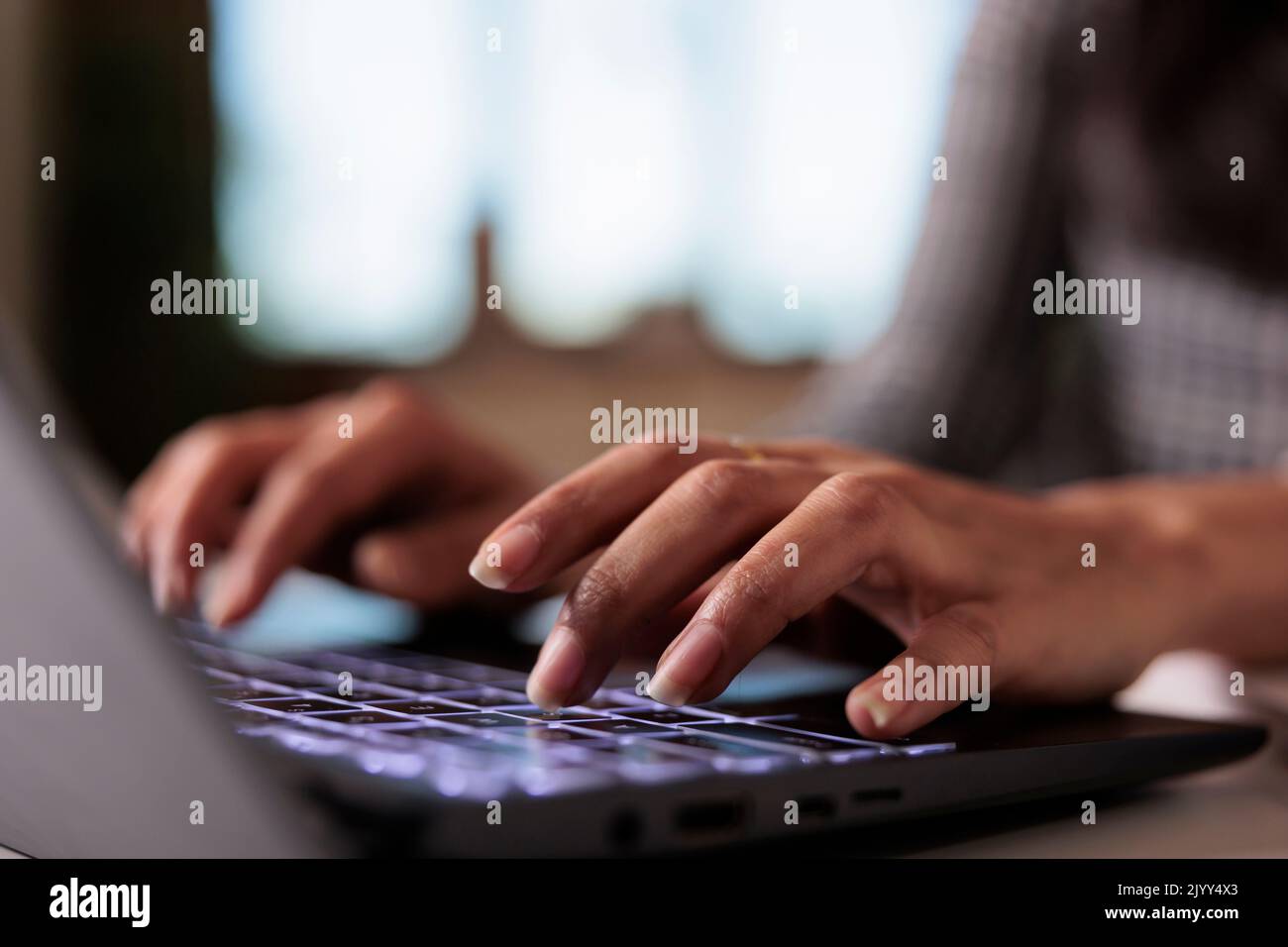 Indian woman typing information on laptop, searching report and sending ...