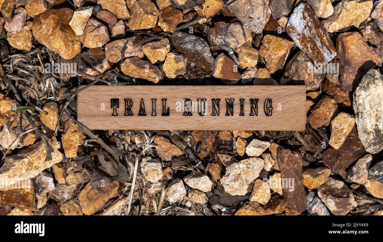 Trail running written on wooden surface. Background stone pattern ...