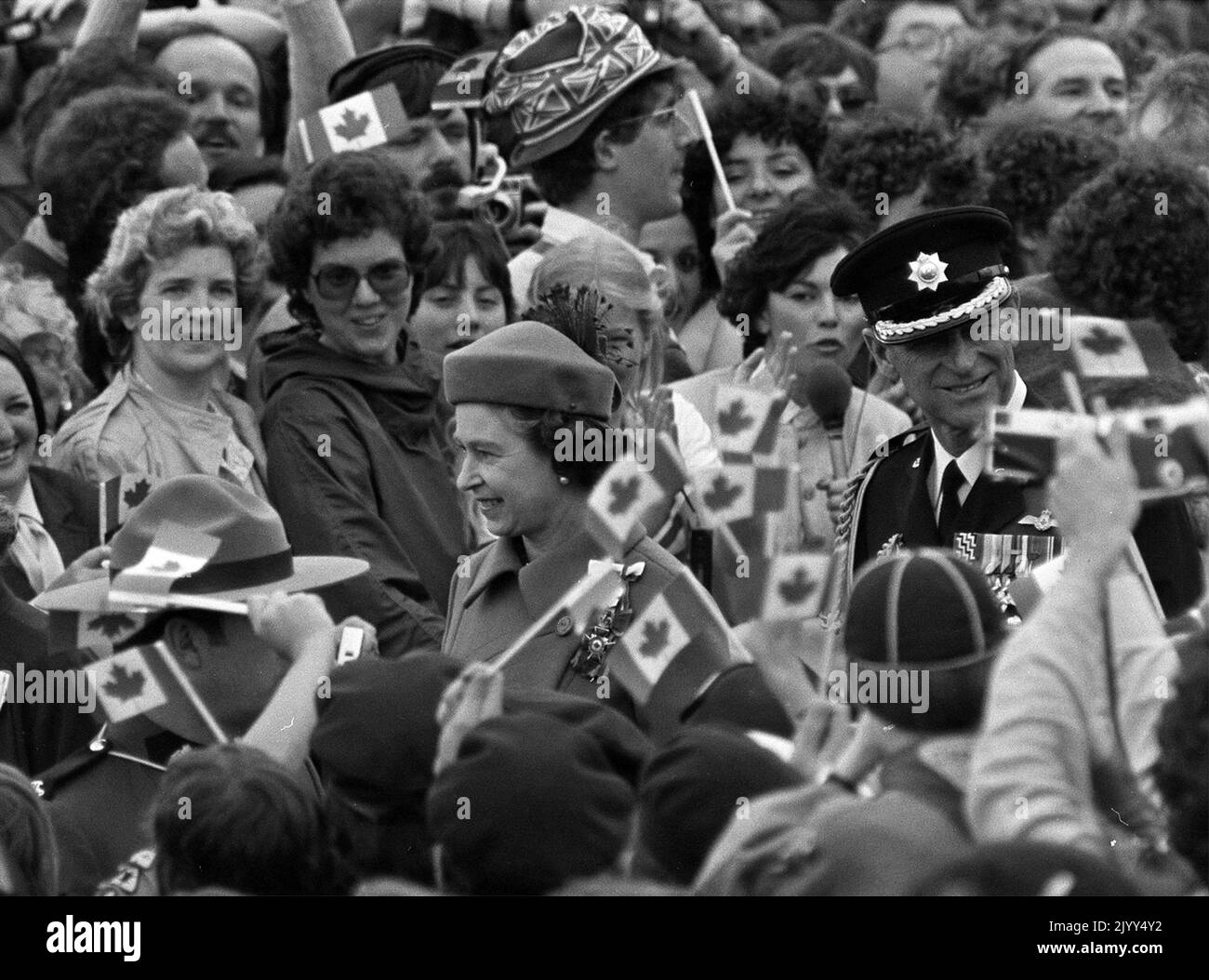 Canadian flags wave as Queen Elizabeth II and Prince Philip walk ...