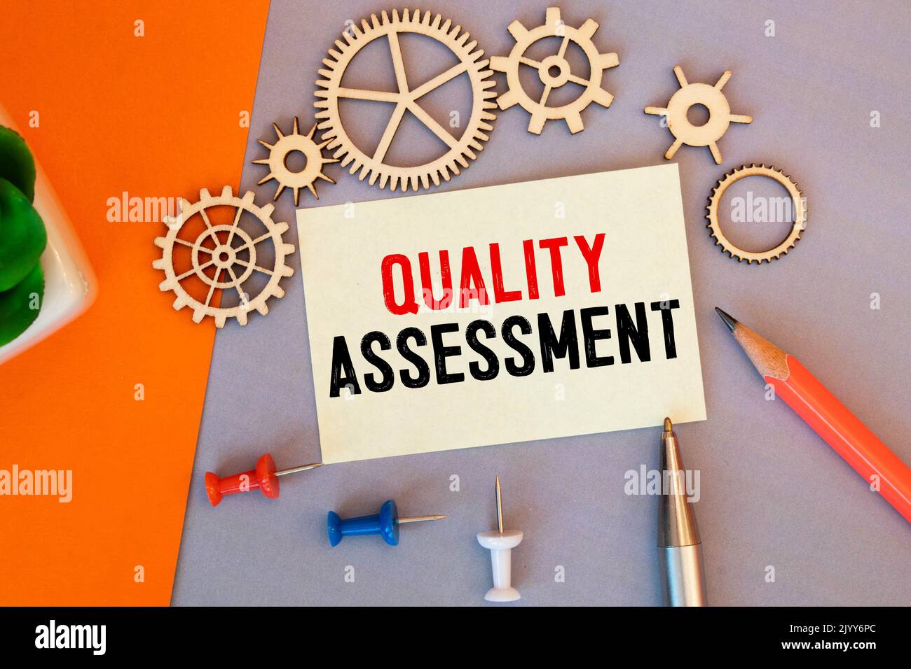 The word quality assessment written on a notebook on business office ...