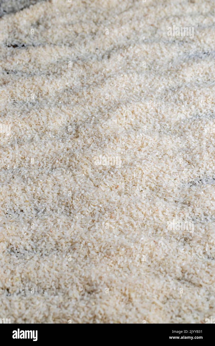 a pile of scattered white rice on the kitchen table, white uncooked ...