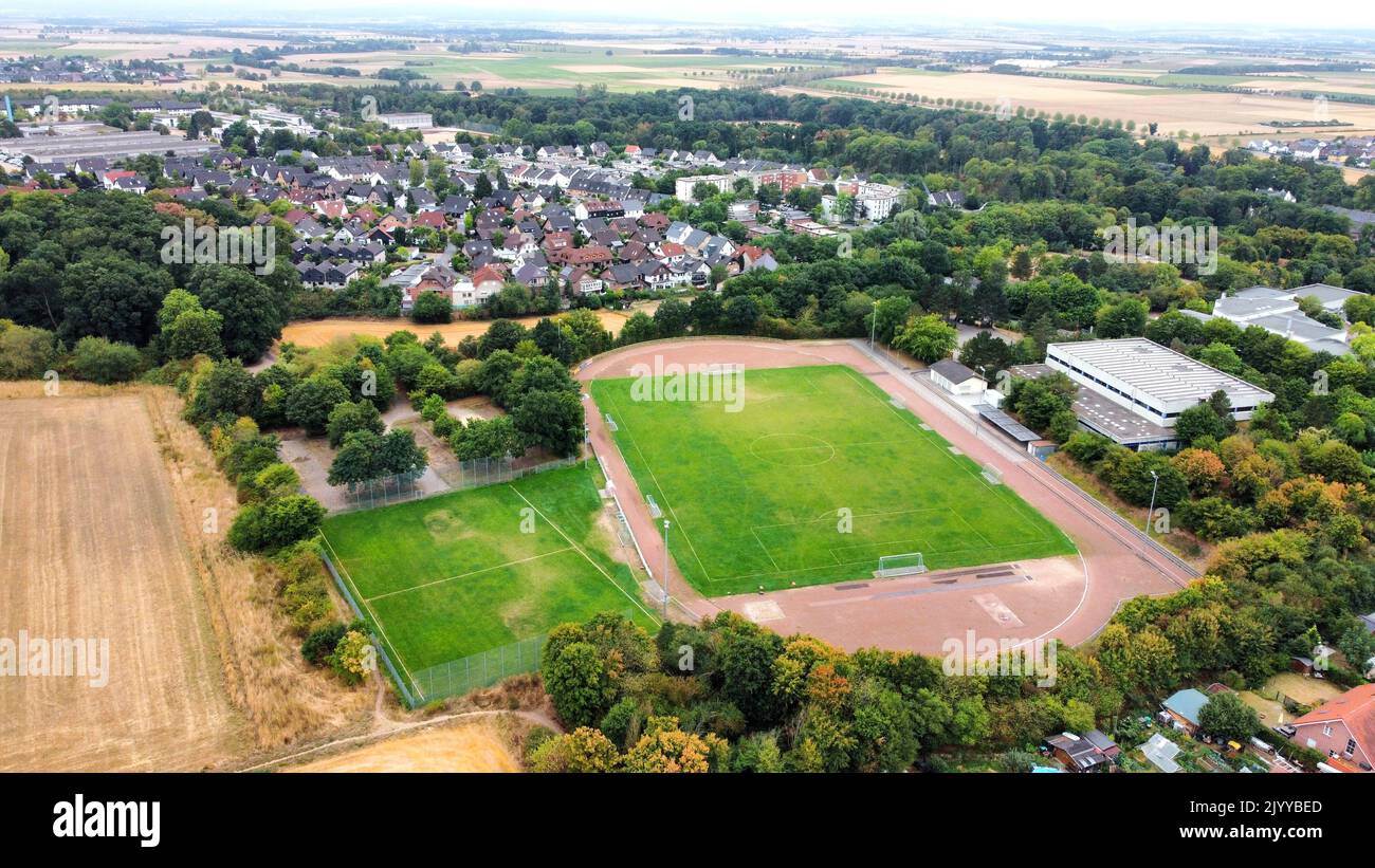Aerial view of a football pitch, fields and homes on public recreation ...