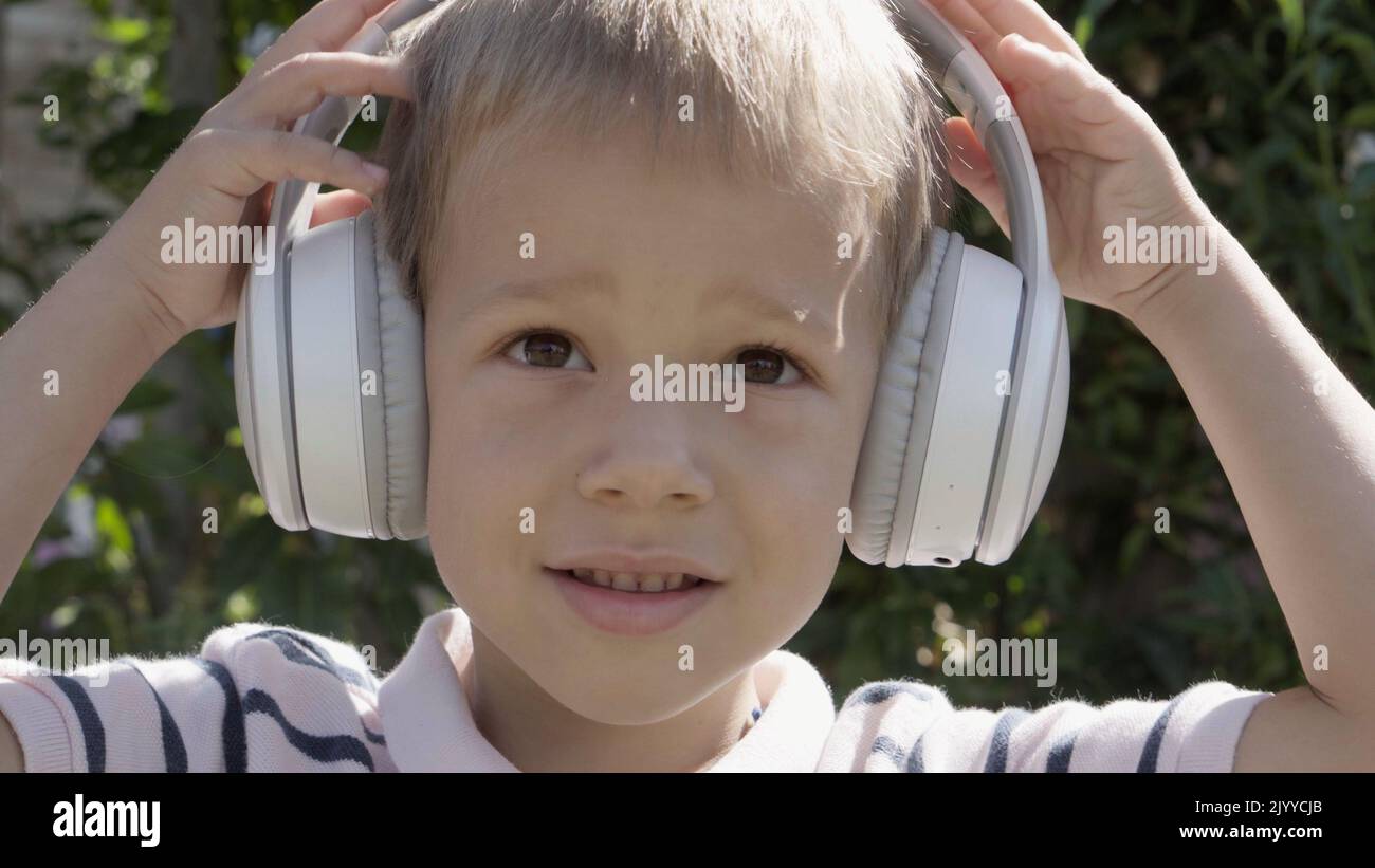 Portrait of Cute Little Boy With Headphones Listening to Music ...