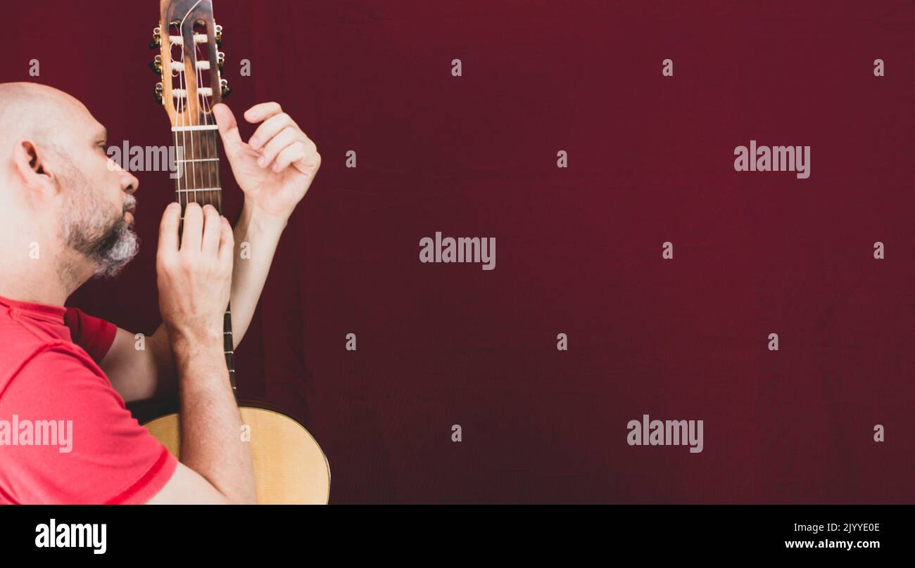 String musical instrument. Mature charismatic male guitarist. guy with ...