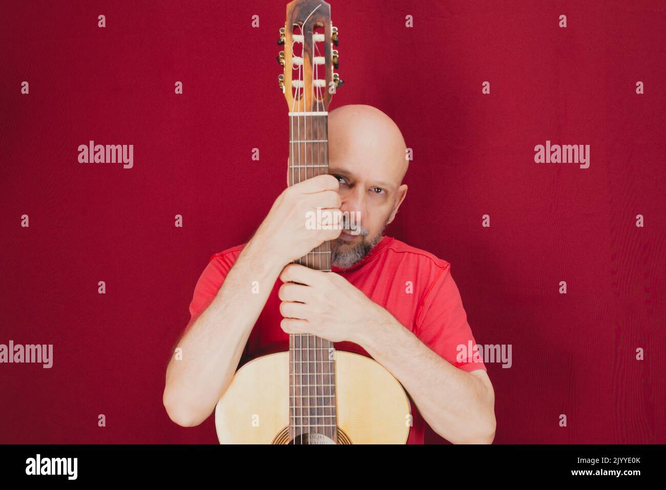 String musical instrument. Mature charismatic male guitarist. guy with ...