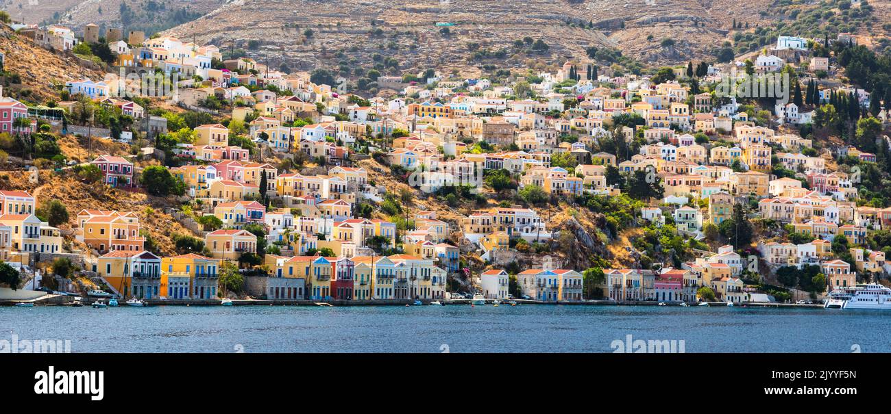 View of the beautiful greek island of Symi (Simi) with colourful houses ...