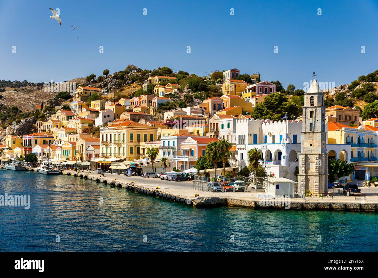 View of the beautiful greek island of Symi (Simi) with colourful houses ...