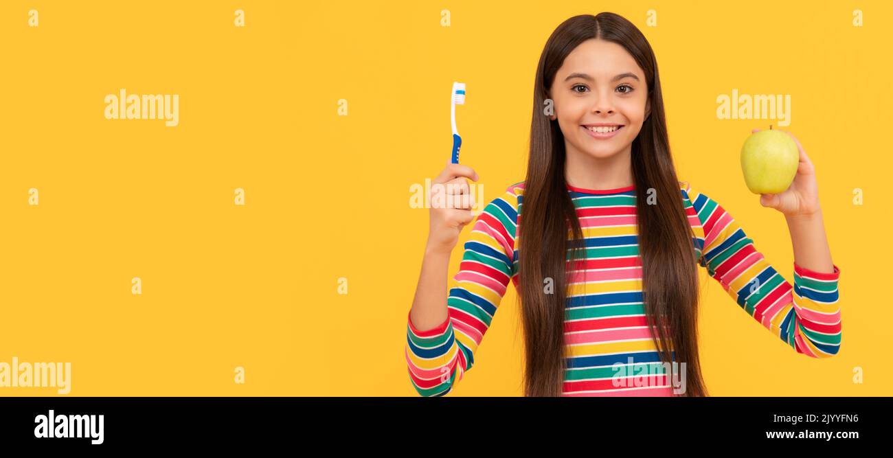 Follow oral hygiene. Happy girl hold apple and toothbrush. Oral hygiene ...