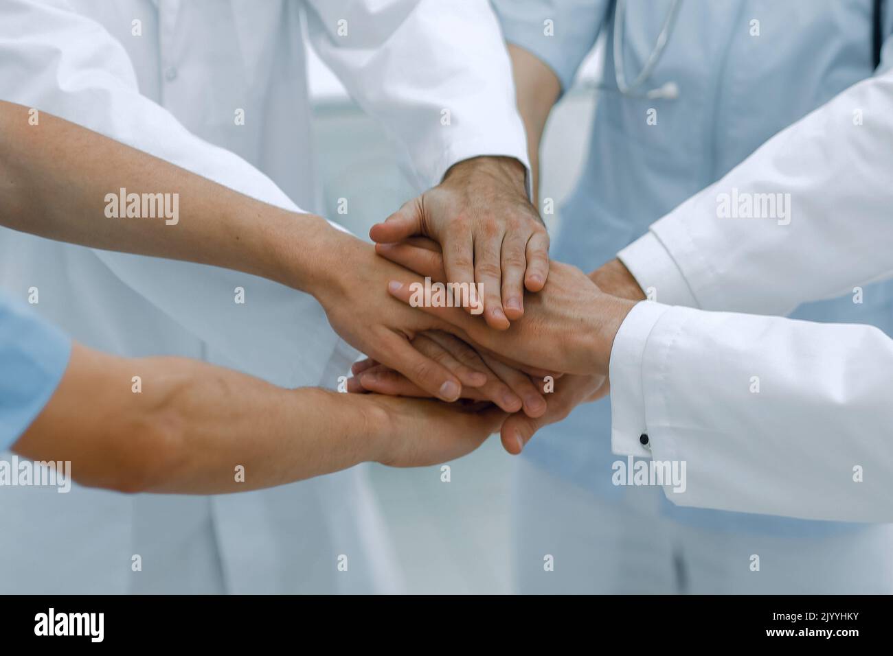doctors holding hands together at hospital Stock Photo - Alamy
