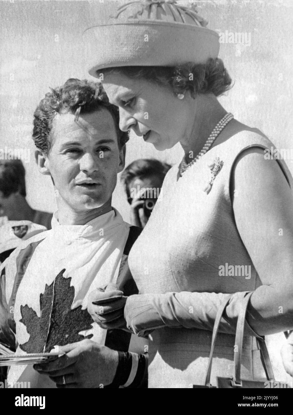 Jockey Ron Turcotte talks with Queen Elizabeth II after she presented ...