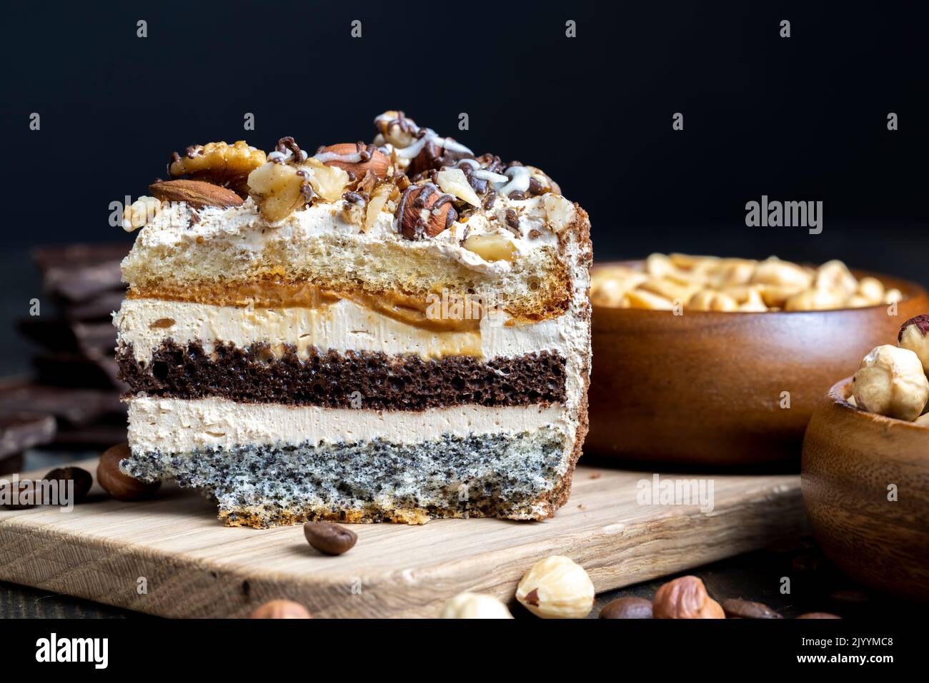 multi-layer cake with different layers, caramel, poppy seeds and cream ...