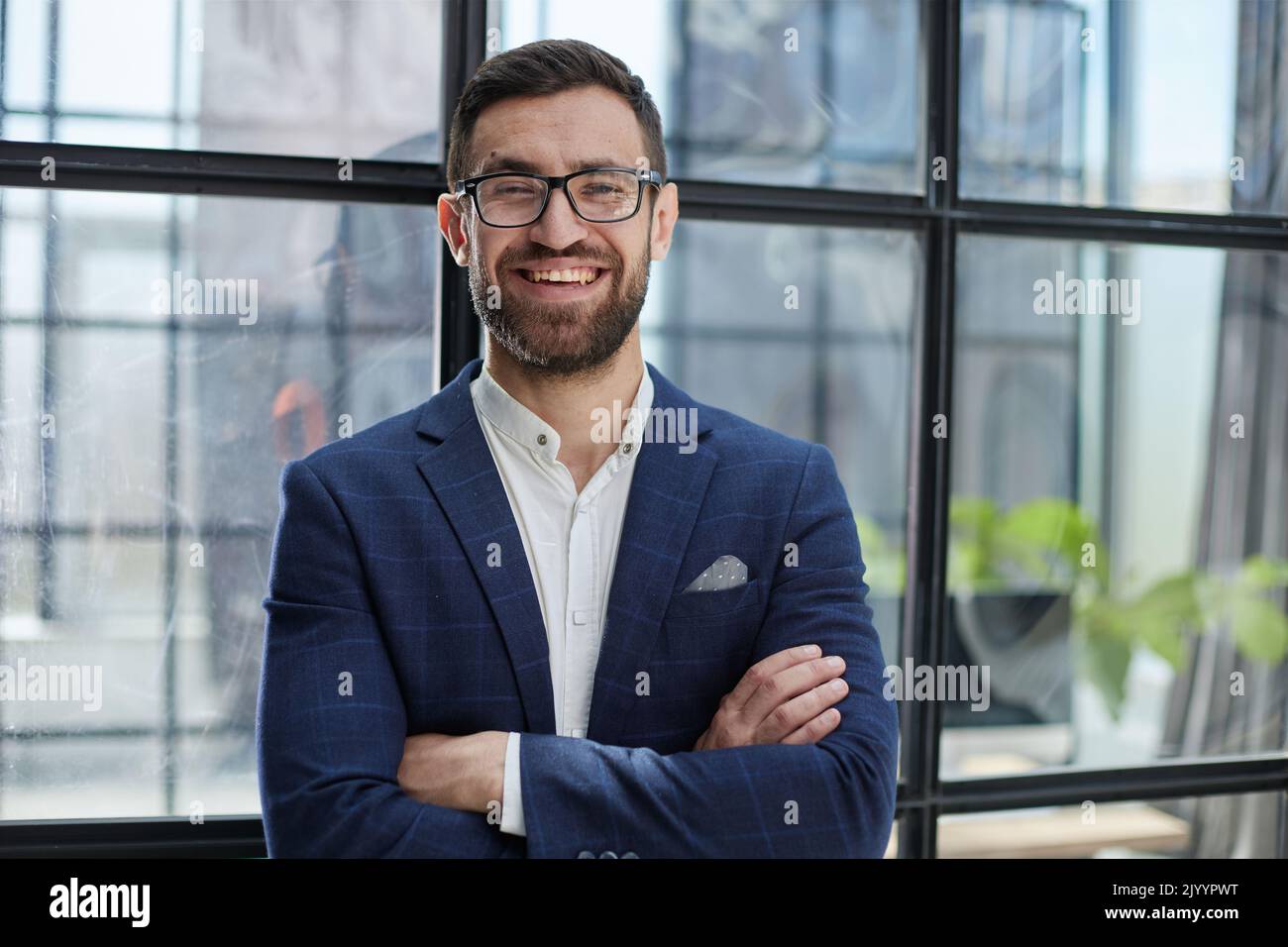 Portrait of successful businessman standing in corner office Stock ...