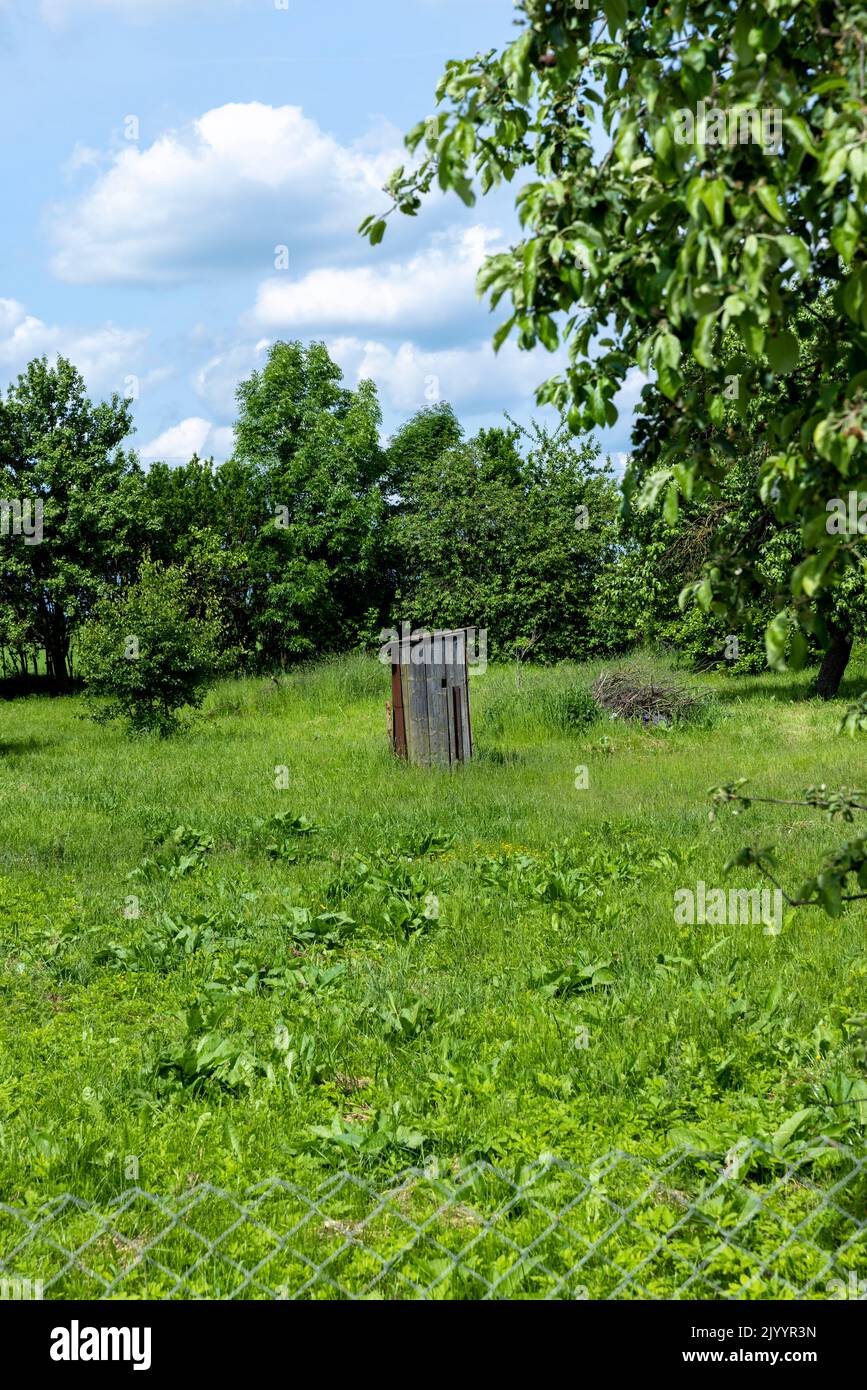 a toilet installed in the countryside in the garden, a primitive rural ...