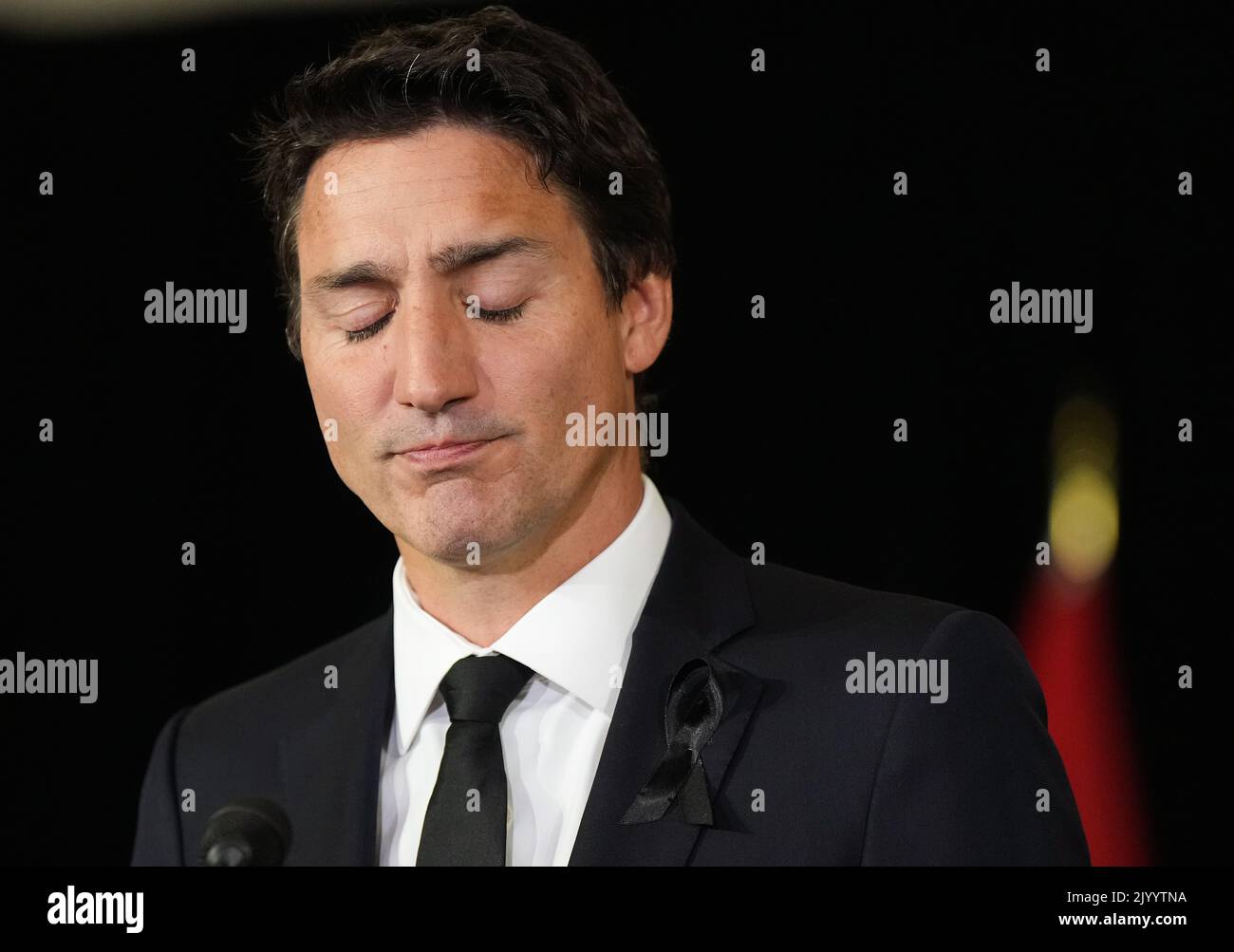Canadian Prime Minister Justin Trudeau wears a black ribbon on his ...