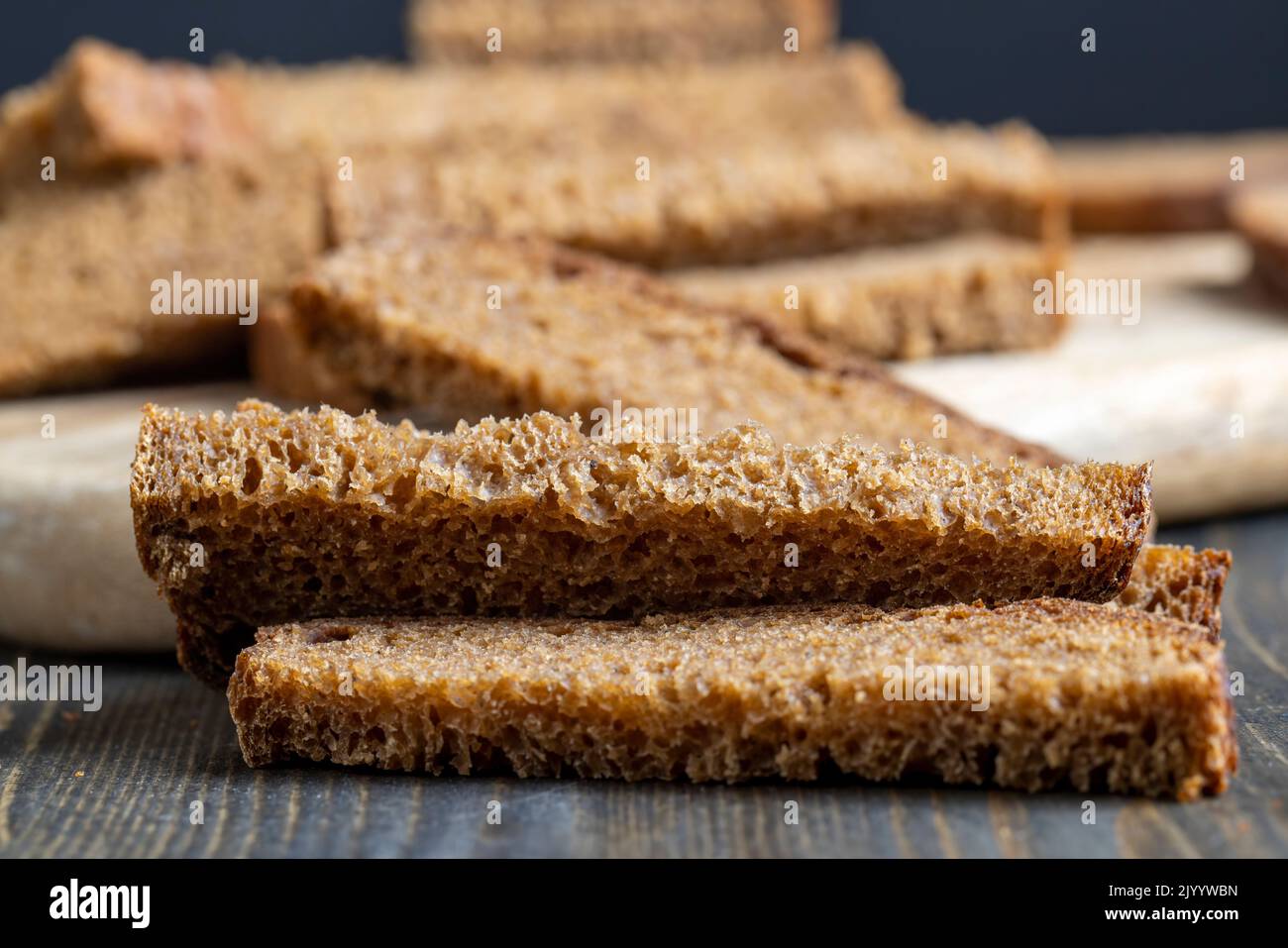 sliced rye bread on a wooden table, soft fresh loaf of bread cut into ...