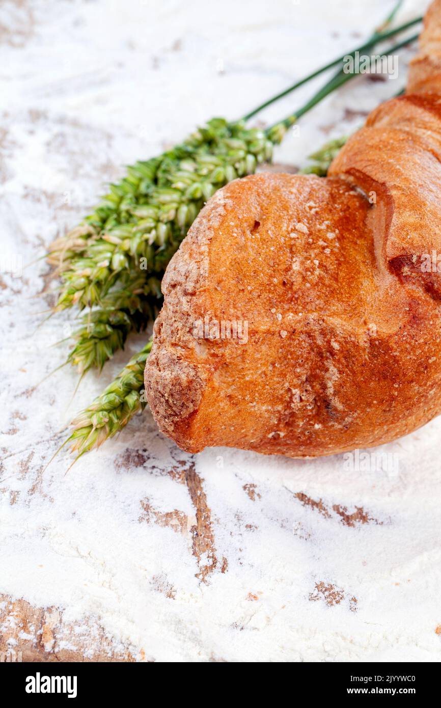 Freshly baked bread on the kitchen table, cooking a simple meal of ...