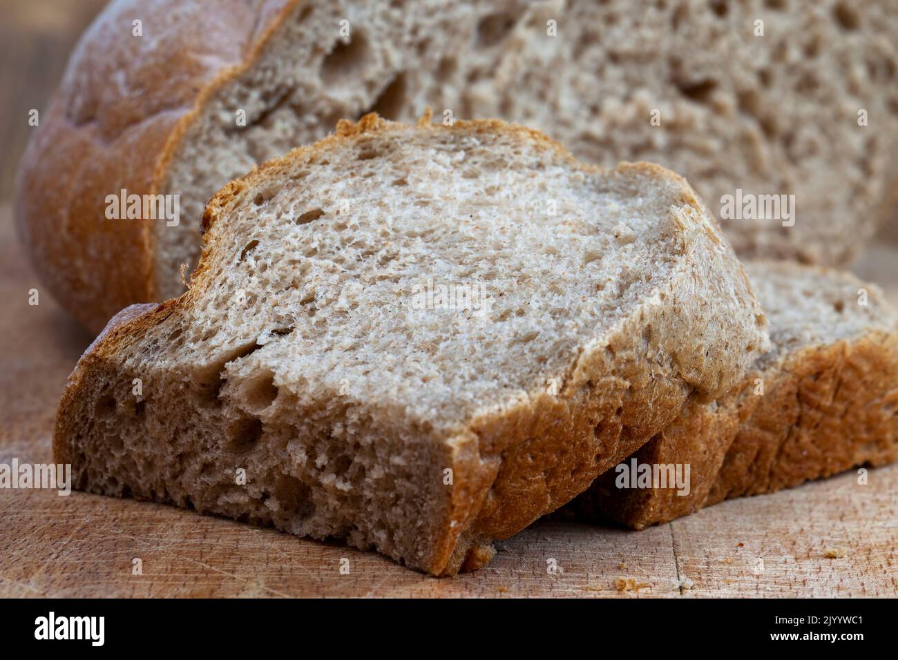 Freshly baked bread on the kitchen table, cooking a simple meal of ...