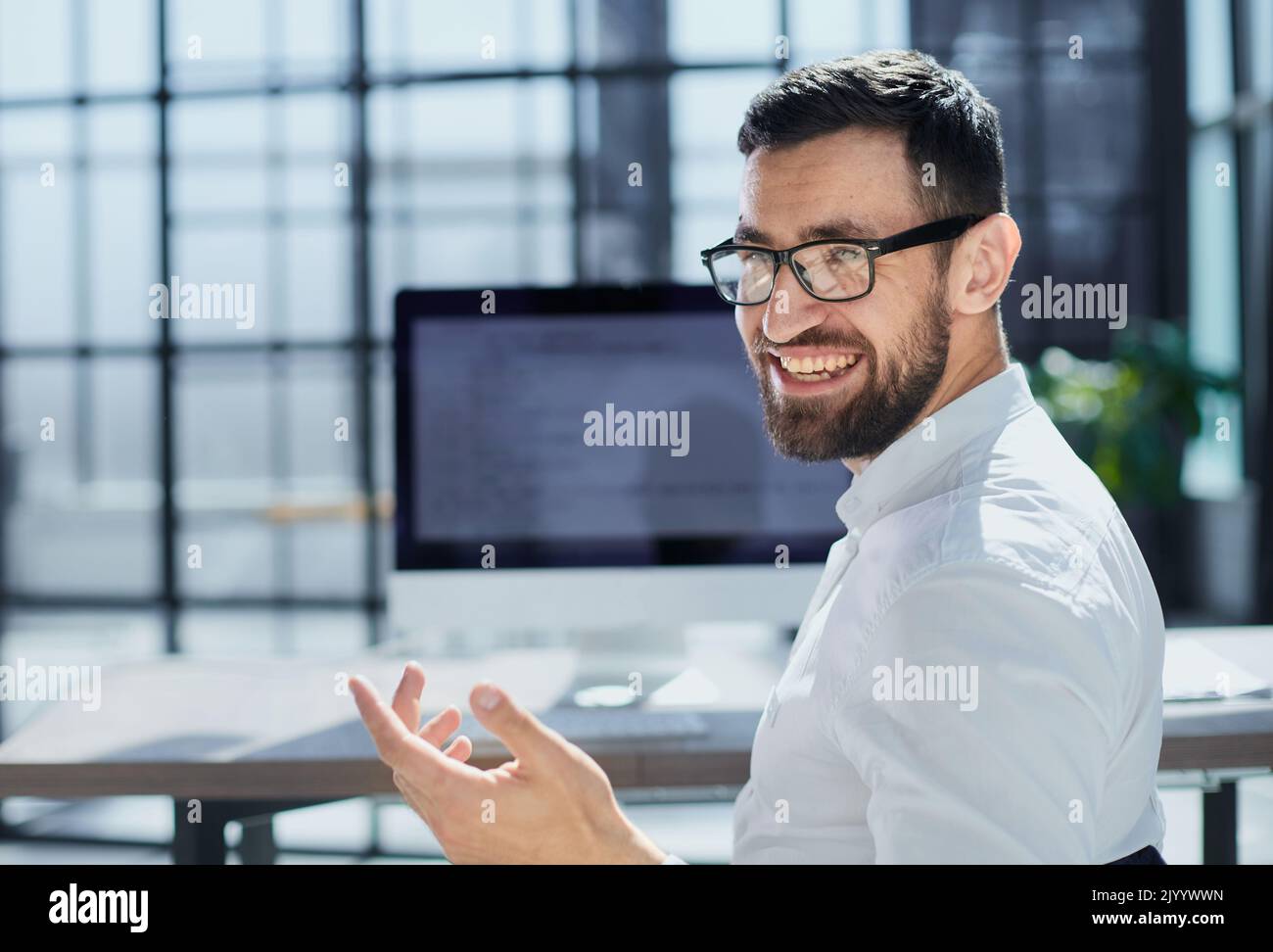 Young employee looking at computer monitor during working day in Stock ...