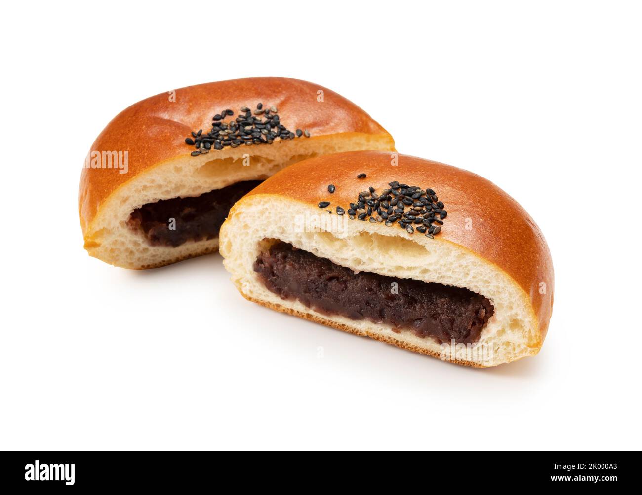 Anpan, cut in half, placed on a white background. Anpan is a Japanese ...